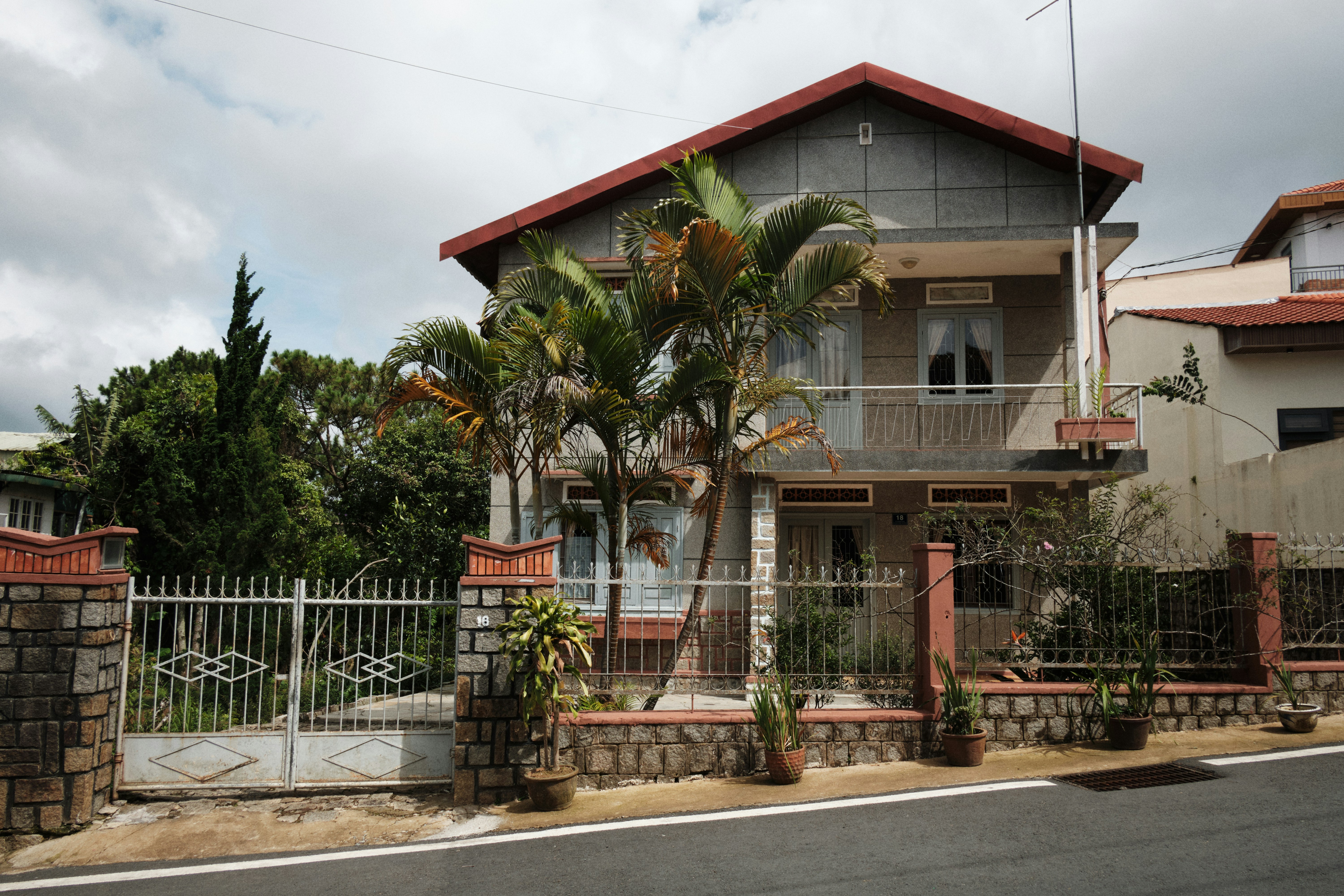 Urban Residence with Palm Canopy and Wrought-Iron Gate