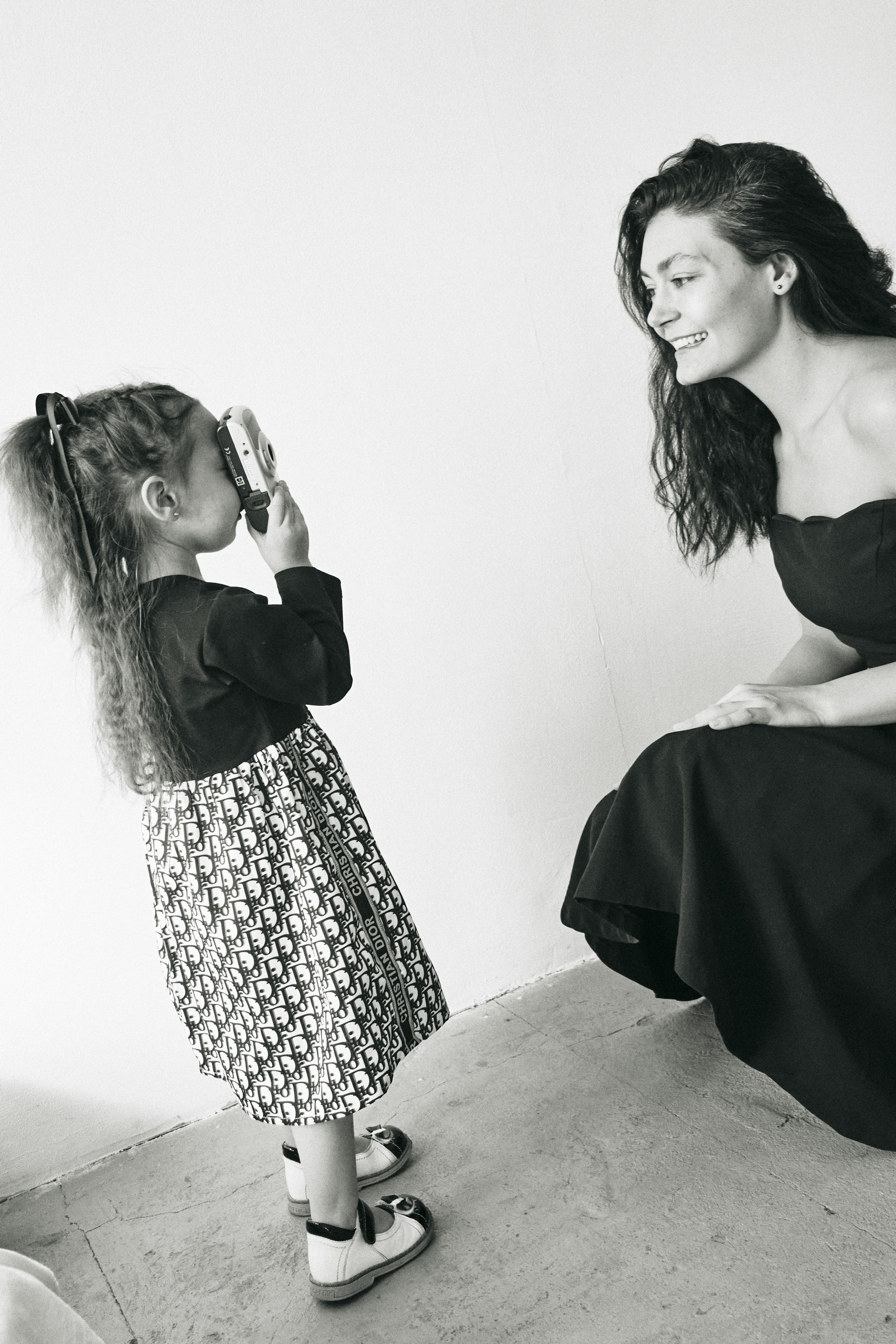 Peek of Connection: Little Photographer Examines a Friendly Gaze