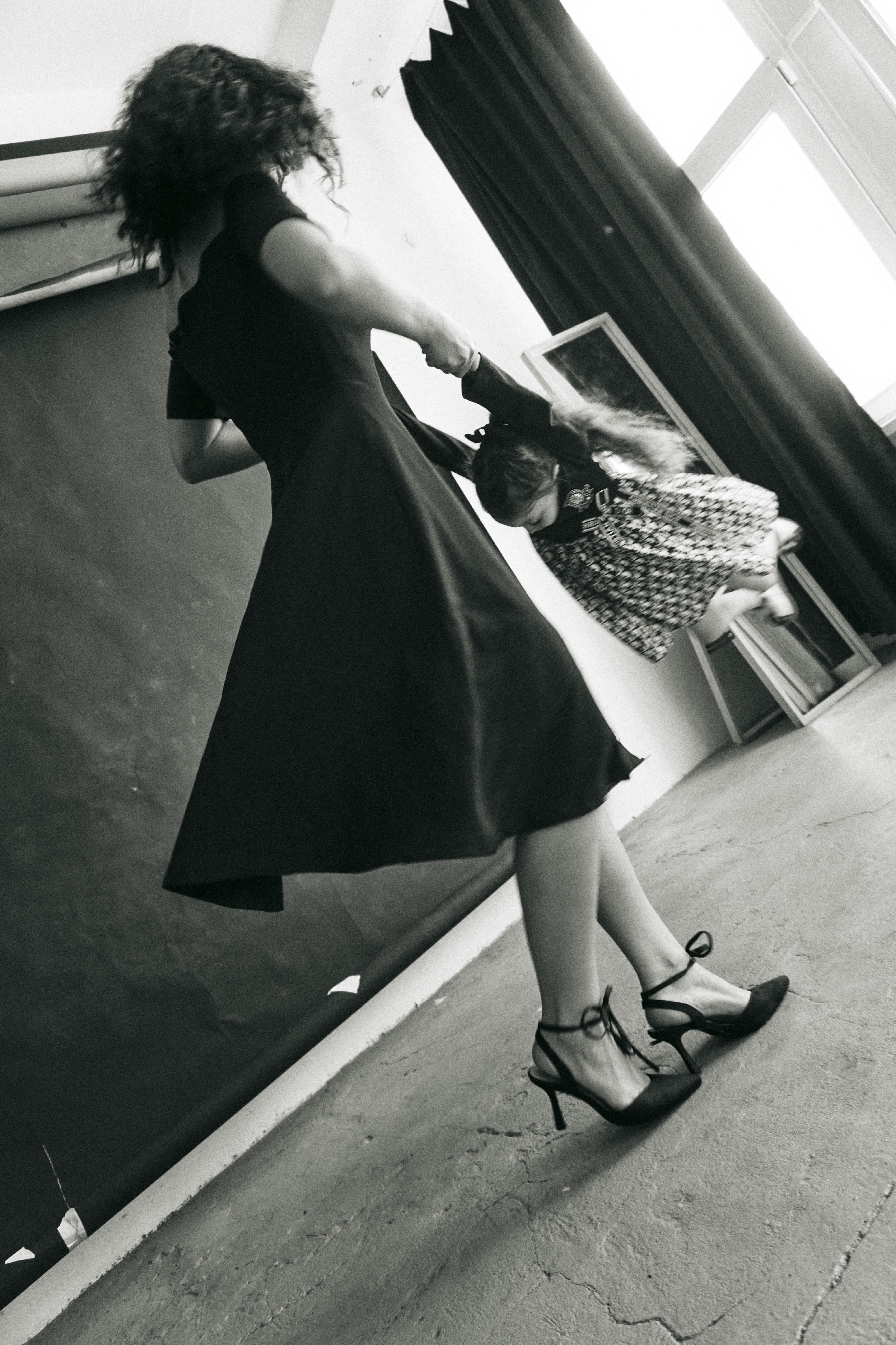 Dramatic ballet in motion: a high-contrast black-and-white studio moment
