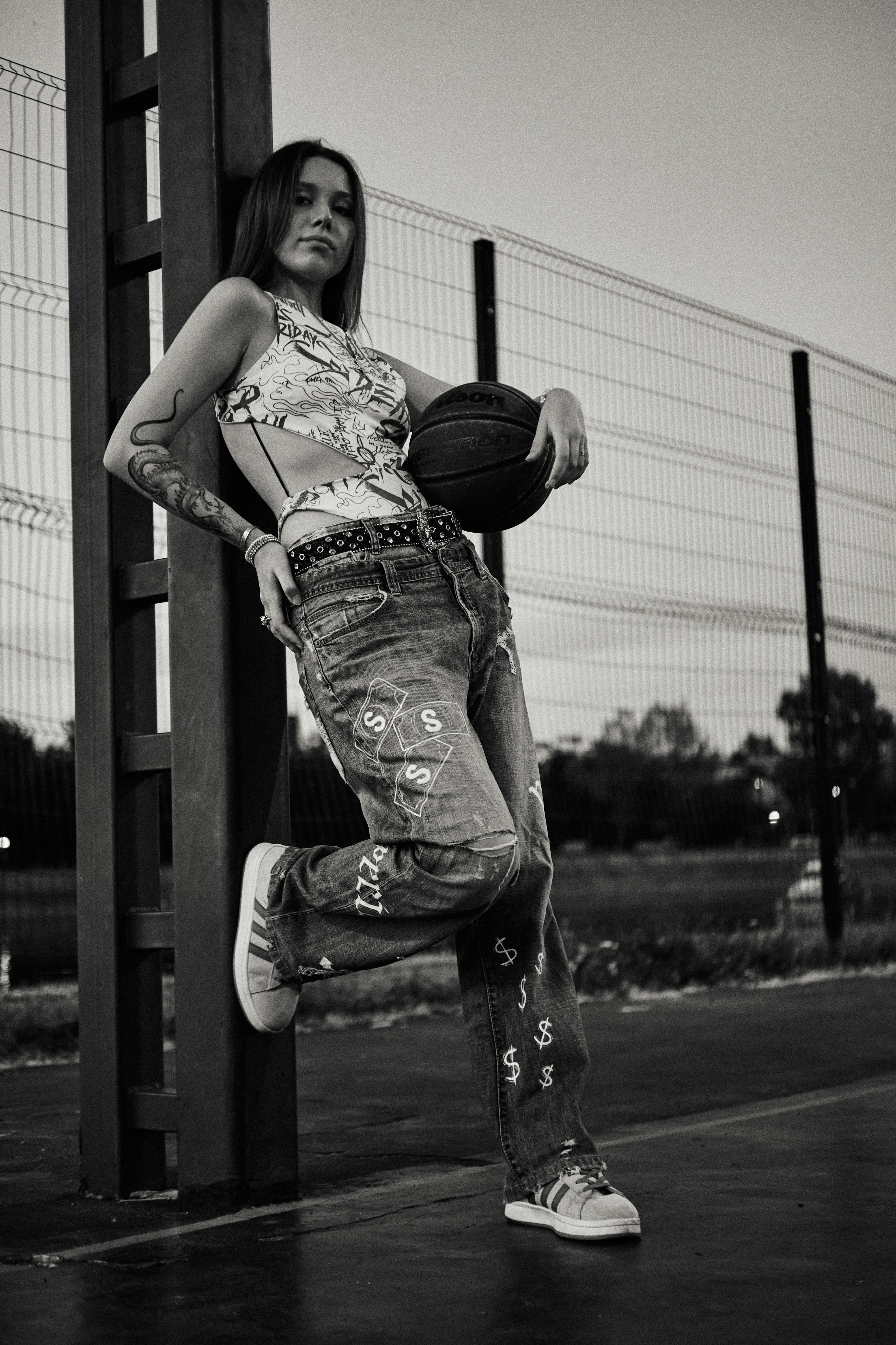 Leaning Against Steel: A Basketball-Breaker Pose