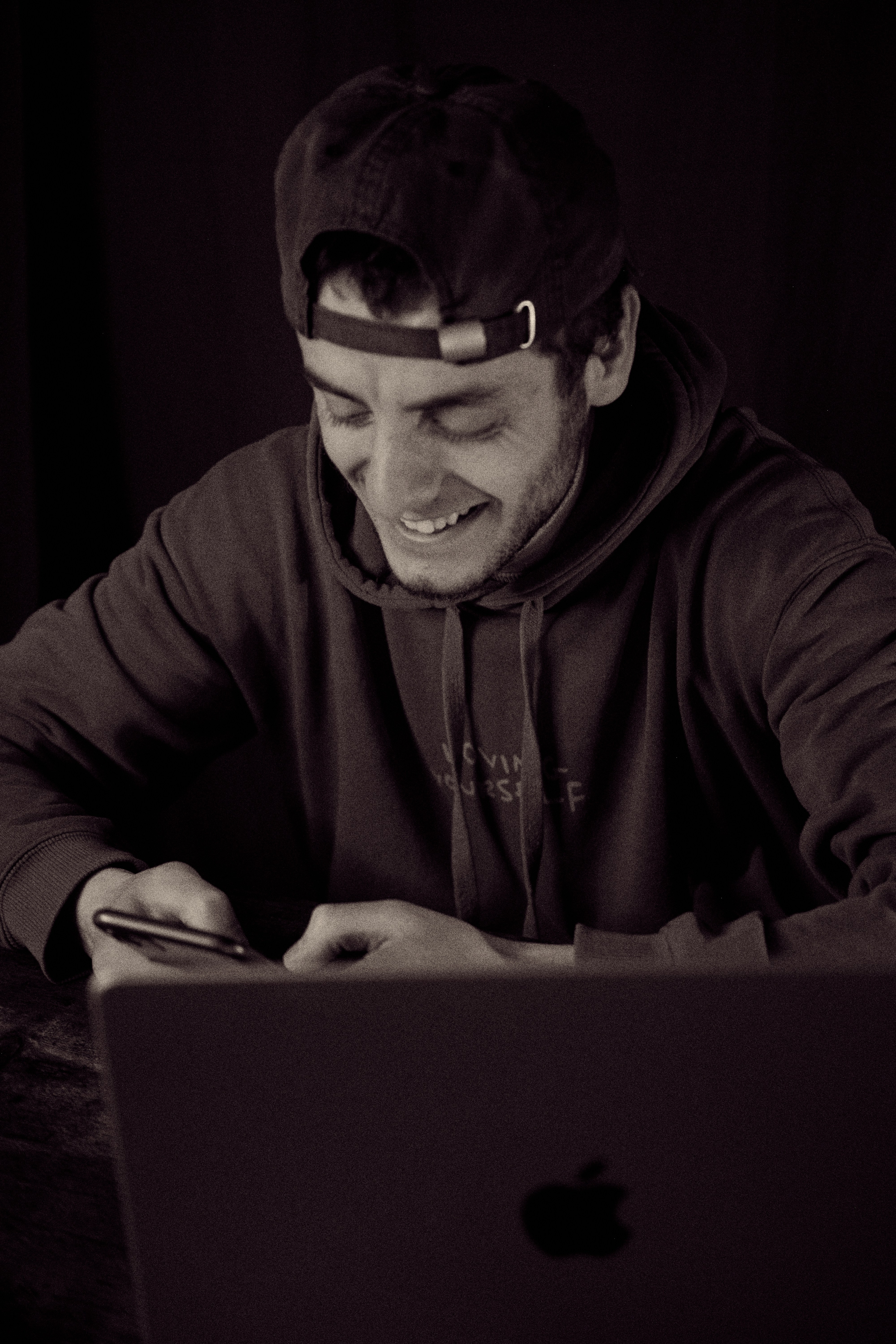Mid-Session Grin: A Candid Moment with Device in Hand