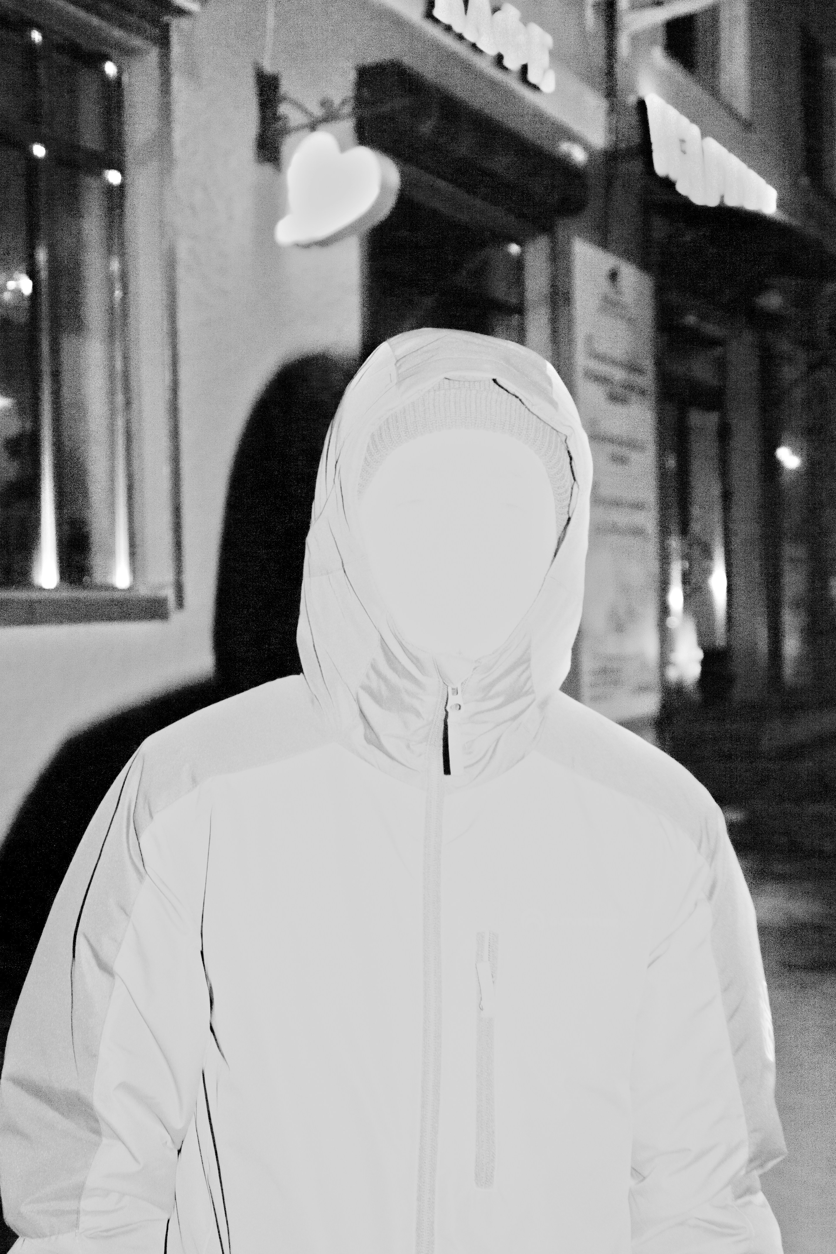 Hooded Figure in Night Street: A Silent Monochrome Moment