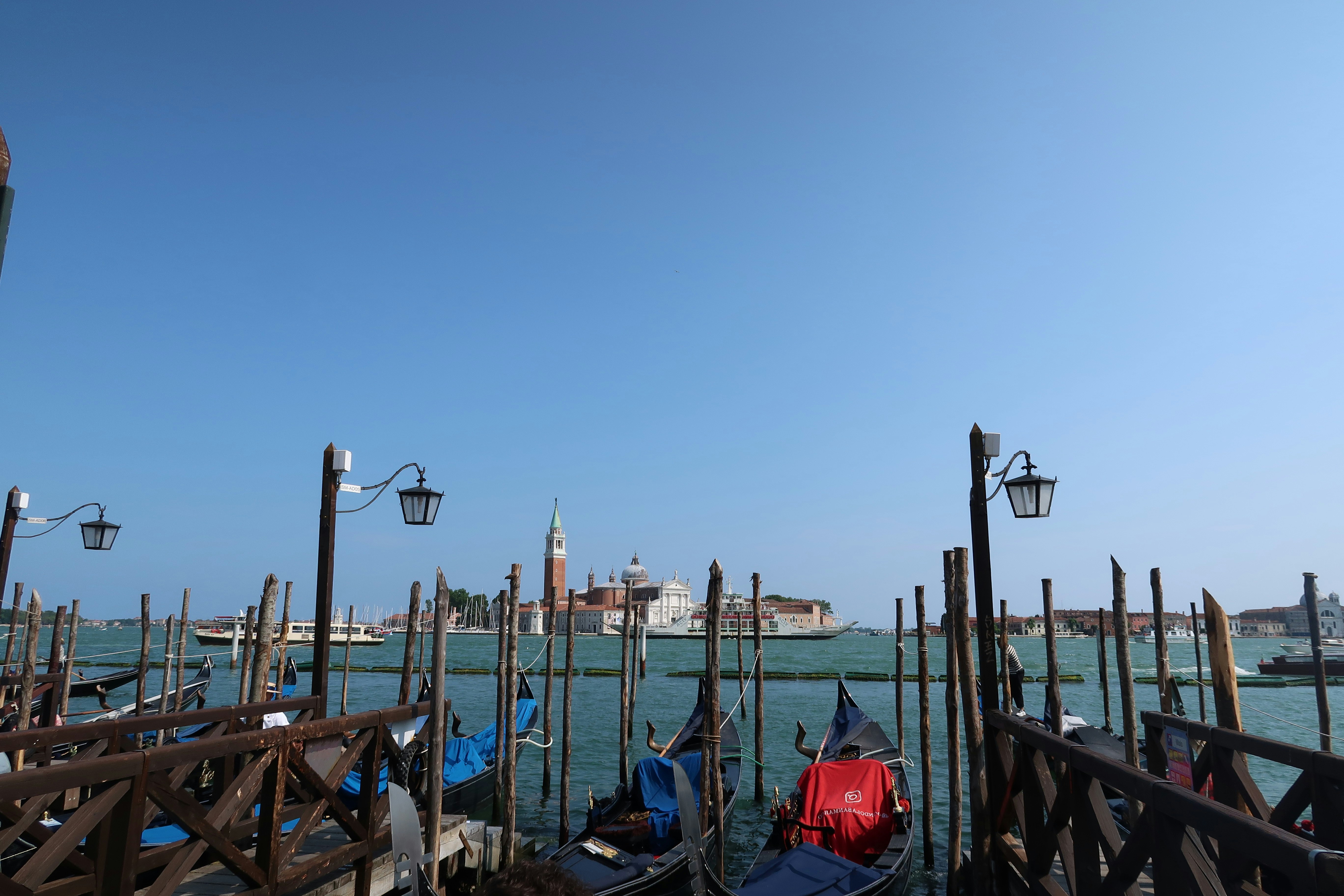 Gondola Row at Dusk: Boats Rest Along a Venetian Pier