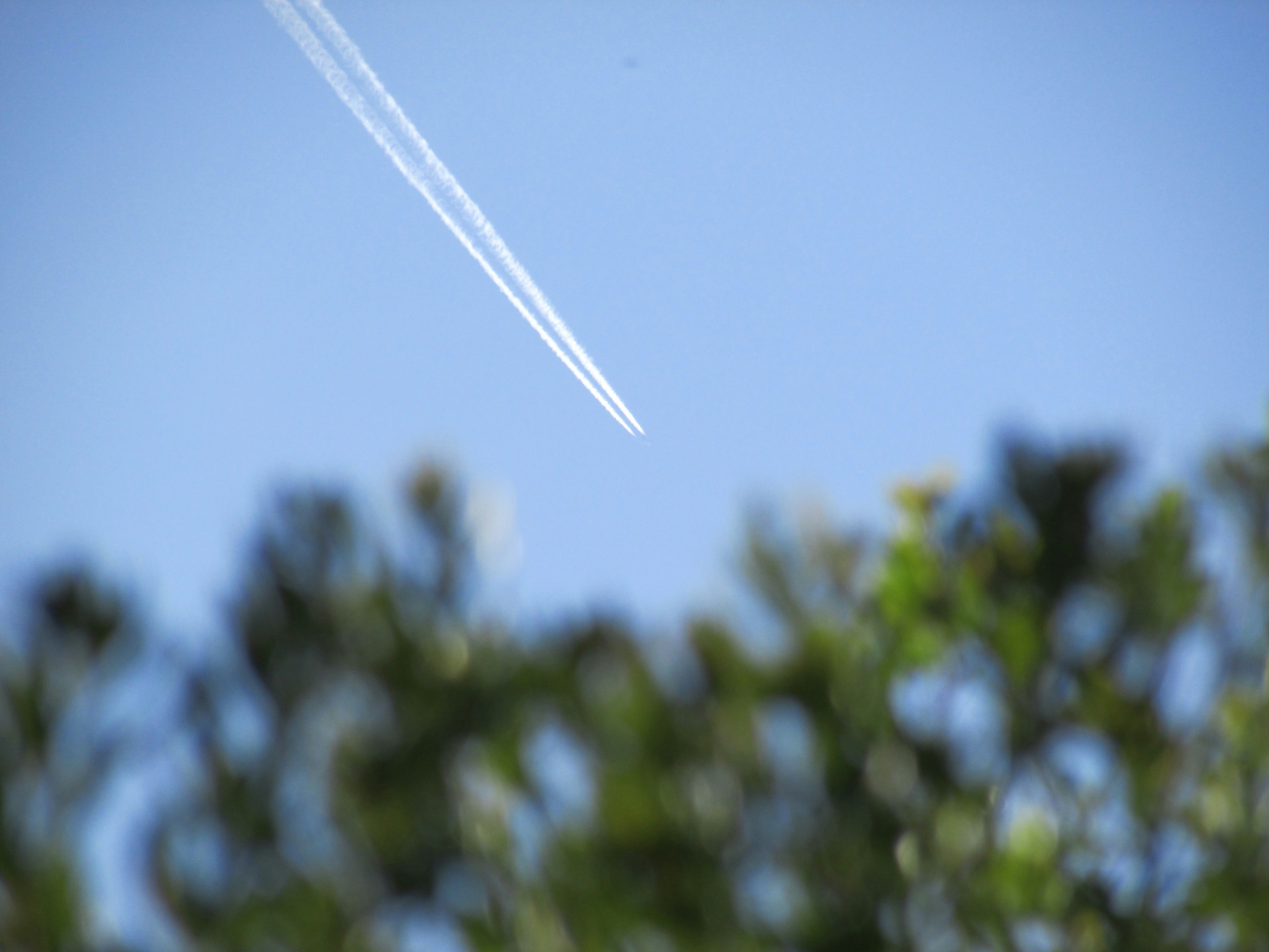 Jet Trail through a Soaring Sky
