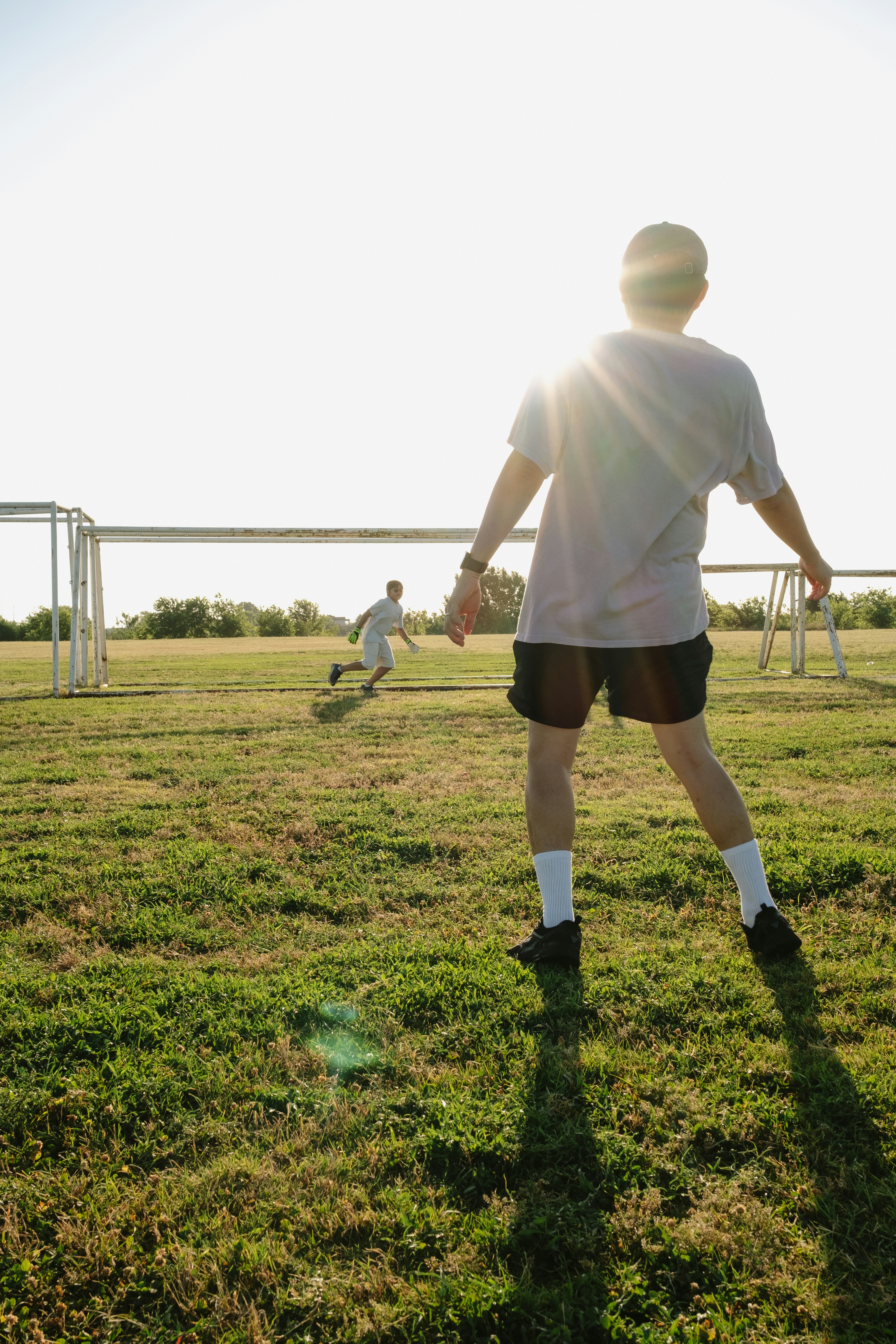 Goalkeeper and Caller: Sunlit Field Showdown