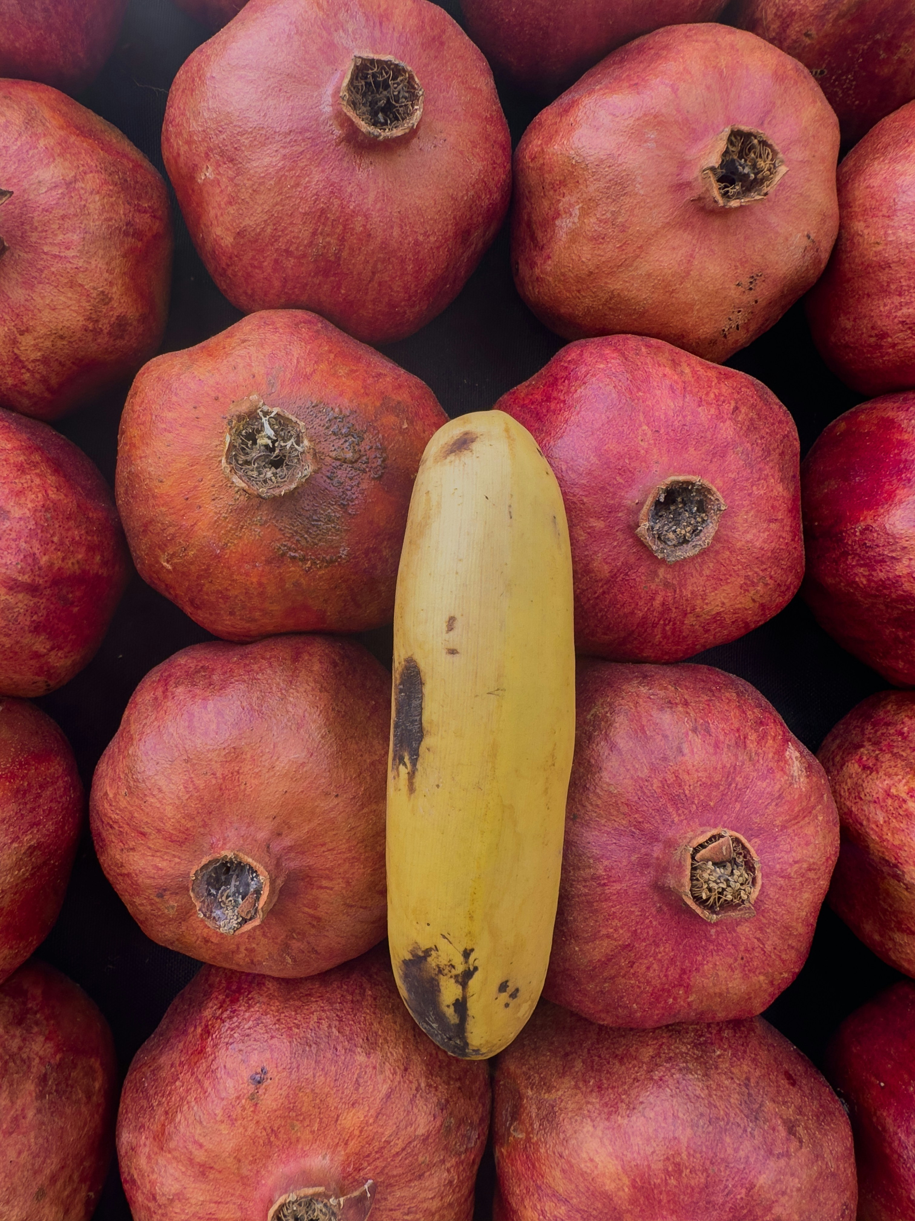 Banana Centered Among Pomegranate Orbs
