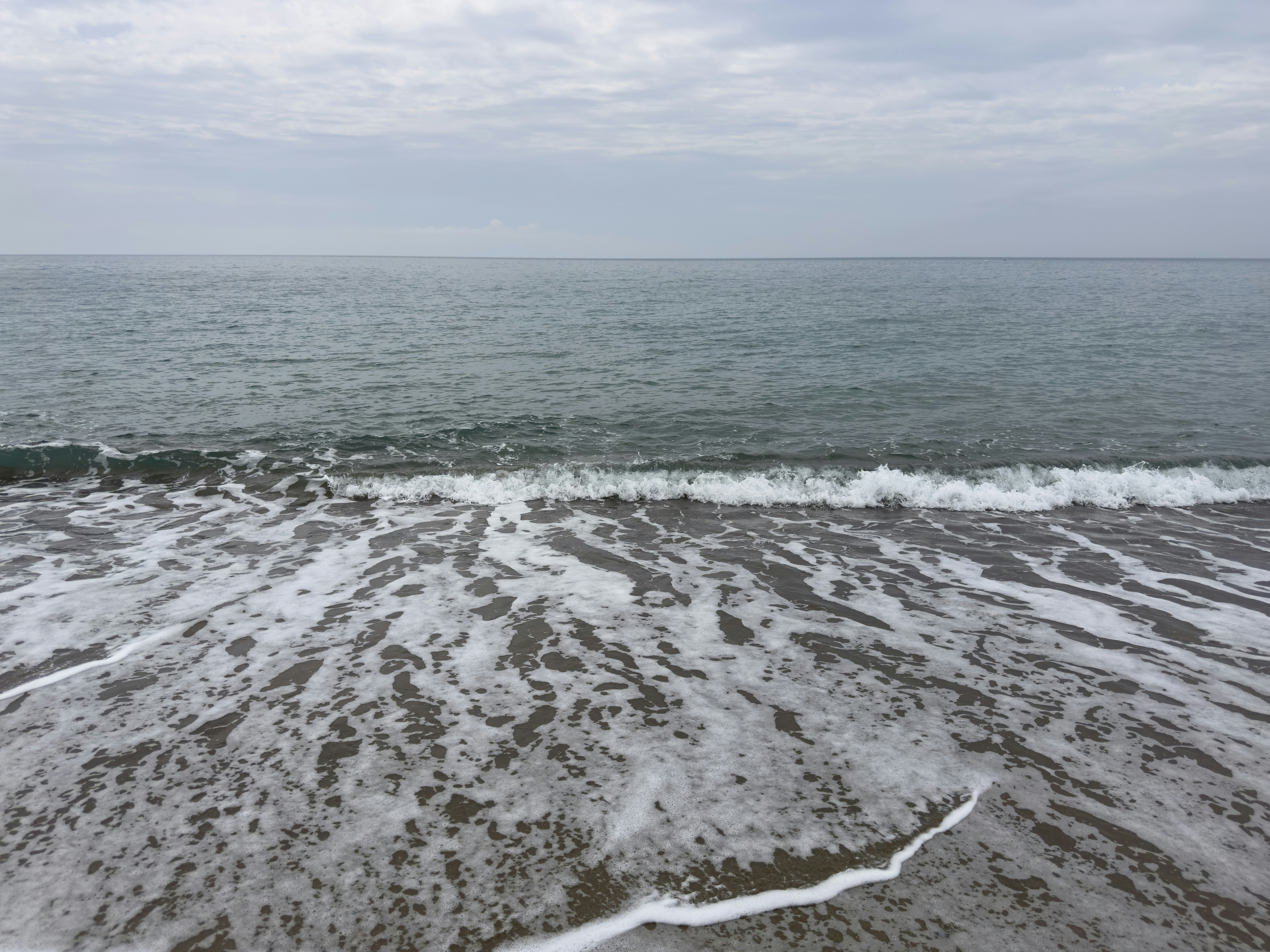 Horizon Whisper: Calm Sea at Distant Shore