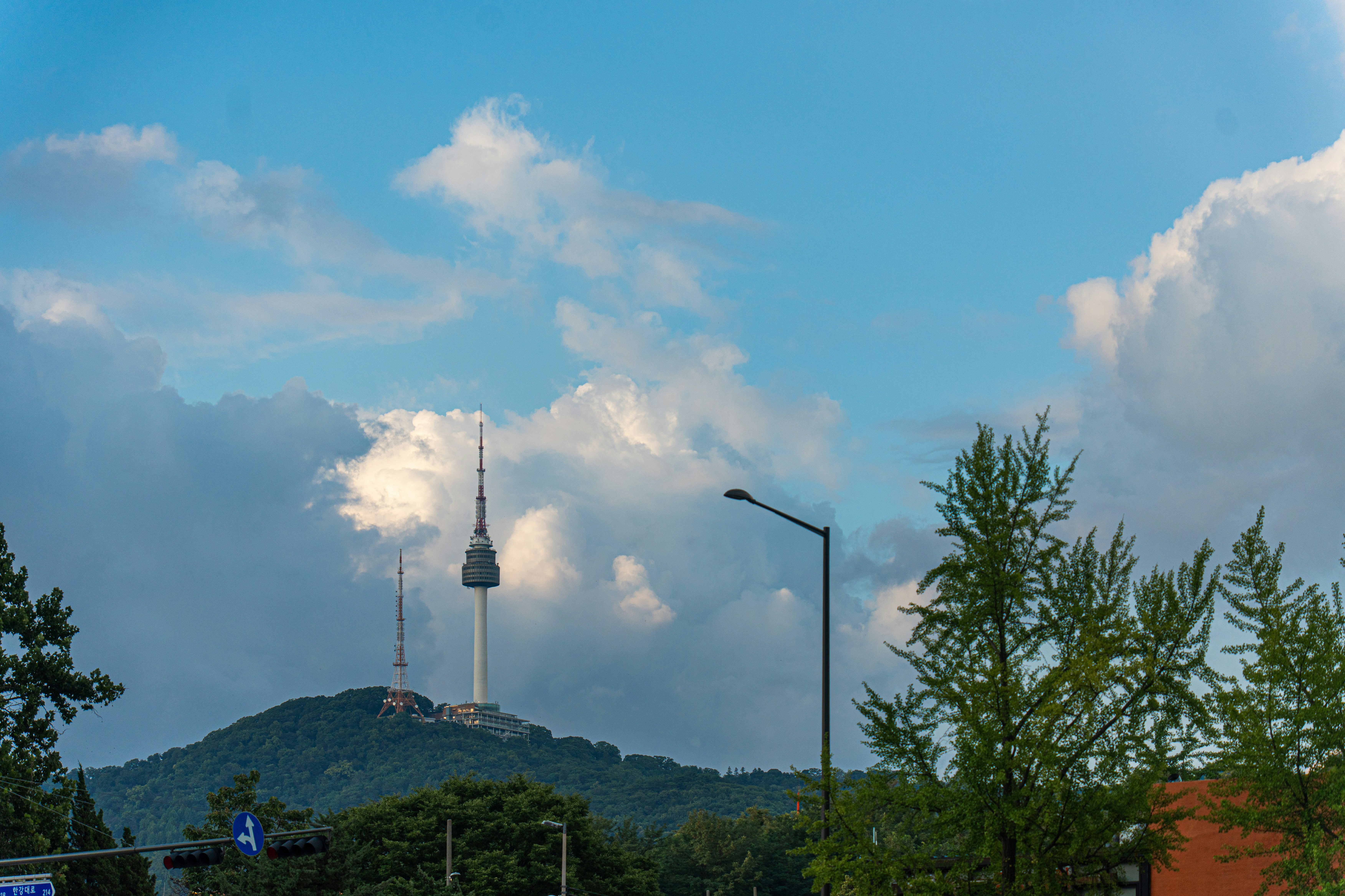 Towering Signal Against a Sky of Puffs