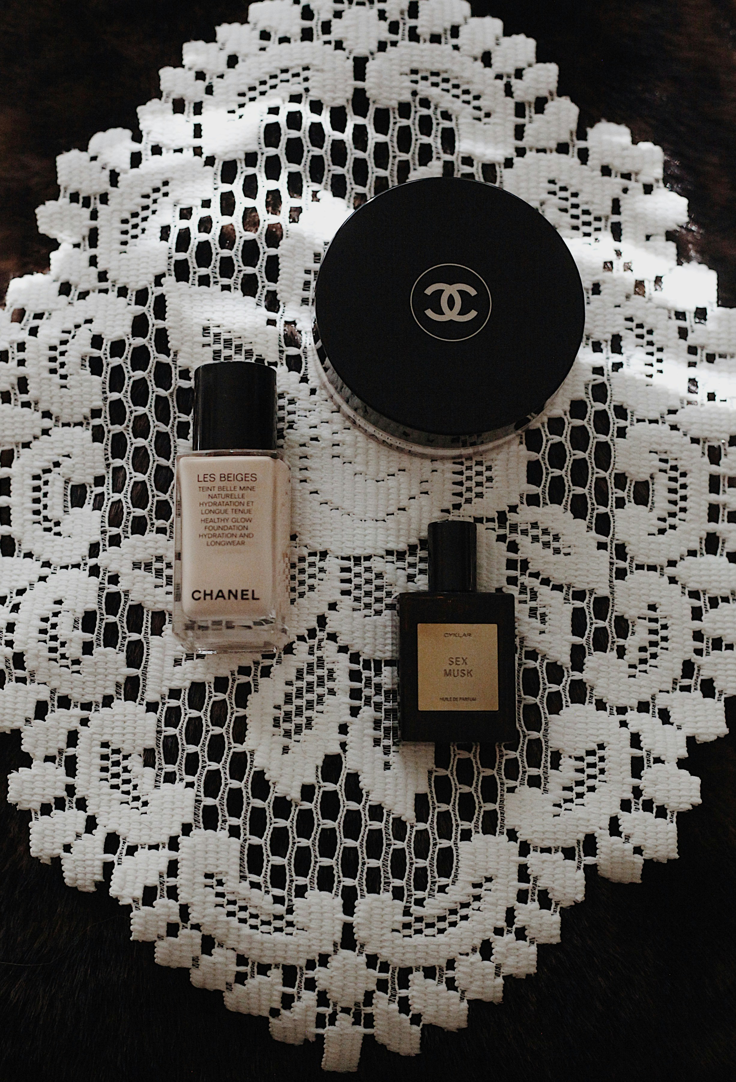 Chic perfume trio on lace: subtle luxury in a still life