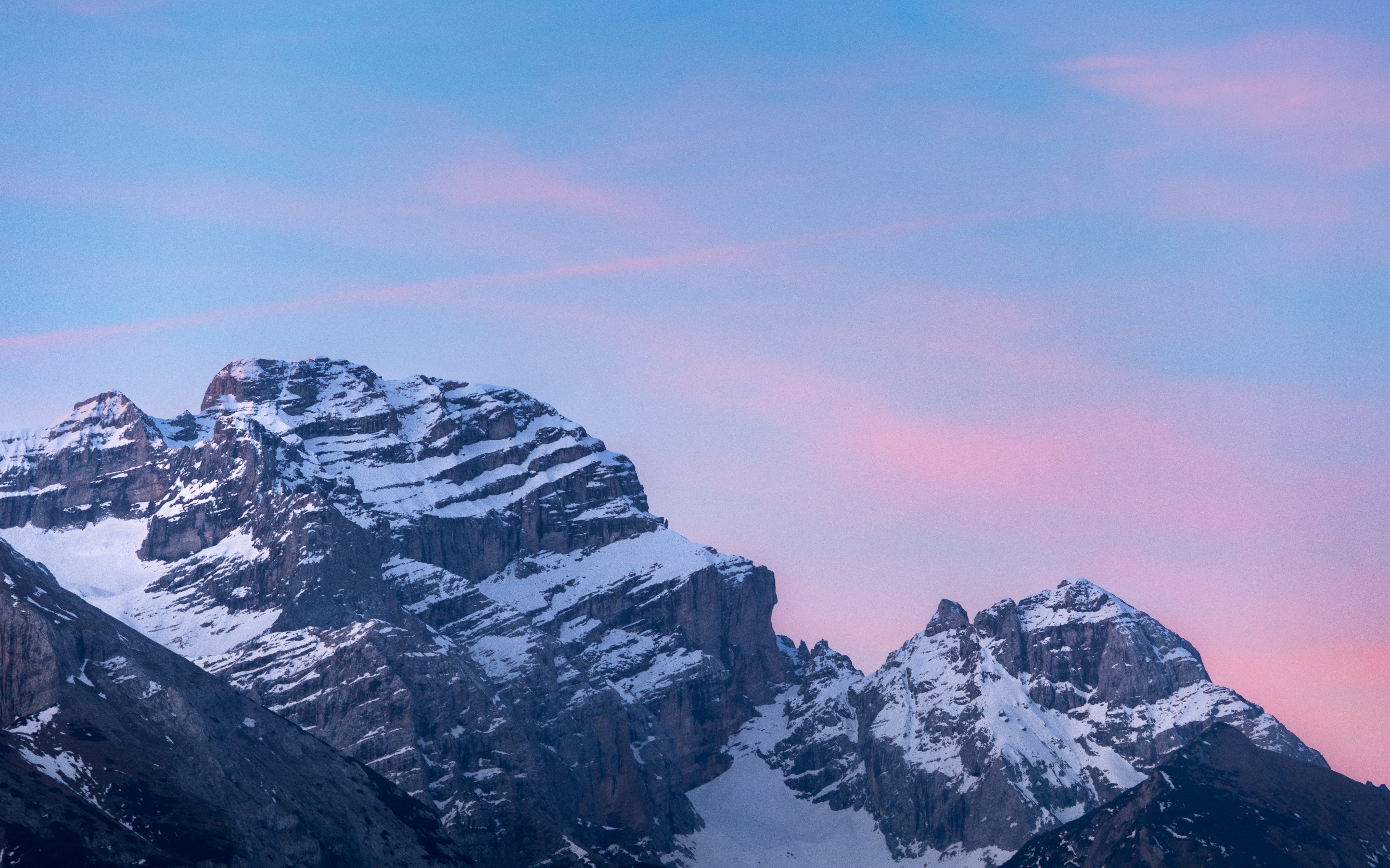 Rose-tinged Summit: Snow-Capped Peaks at Twilight