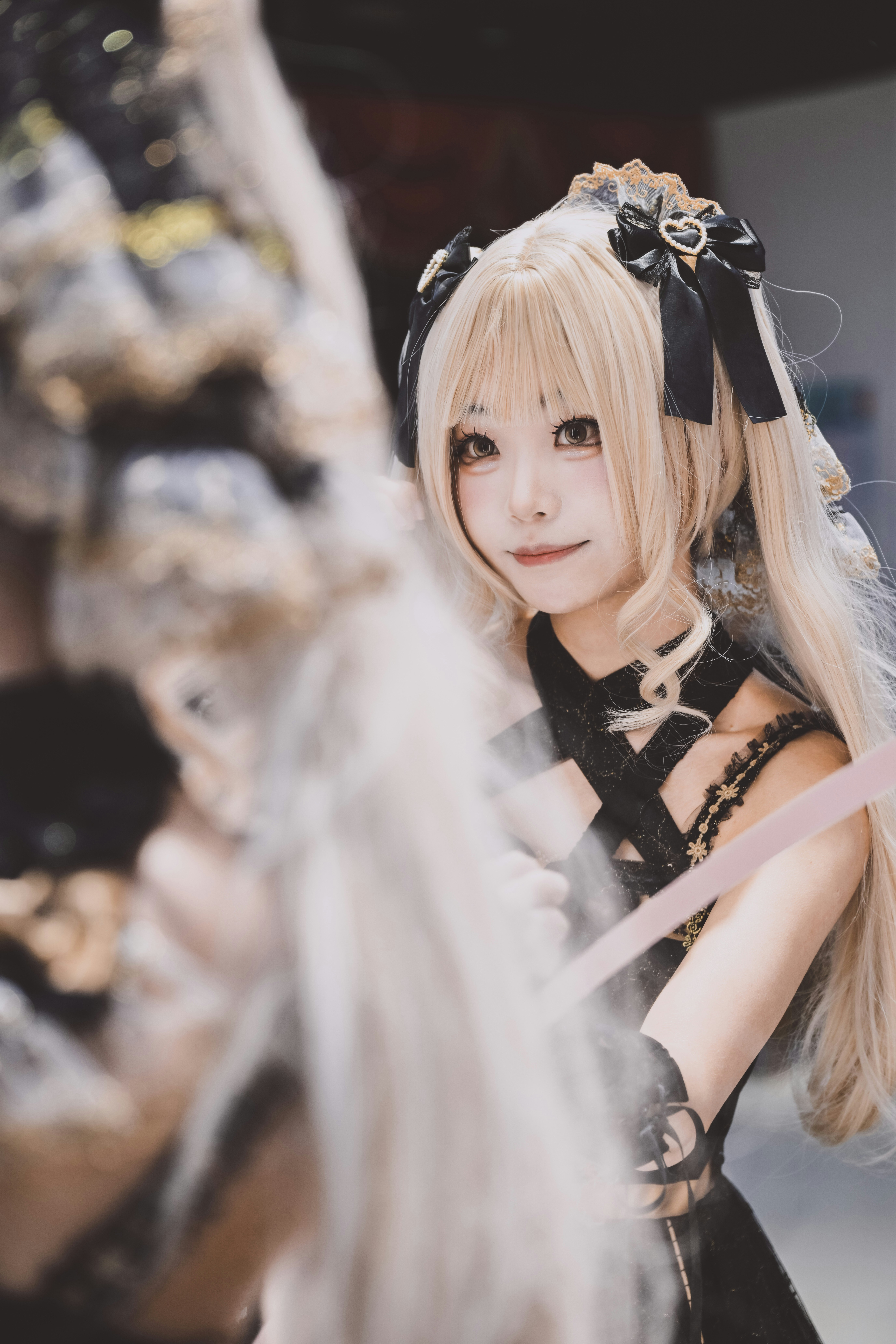 Blonde cosplay muse in lace and ribbons catches the gaze