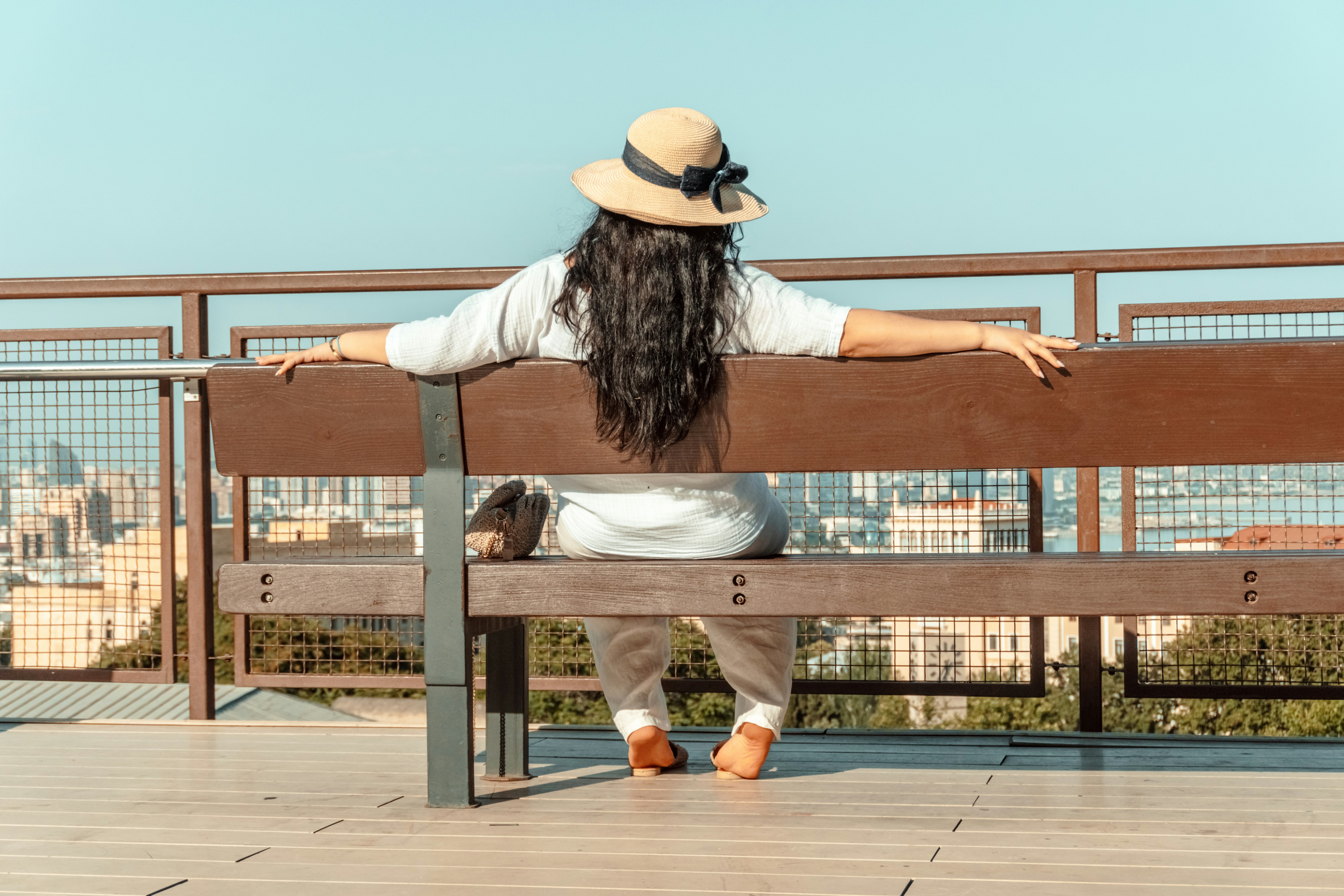 Seated on a Riverside Balcony: Back View with Wide Horizon