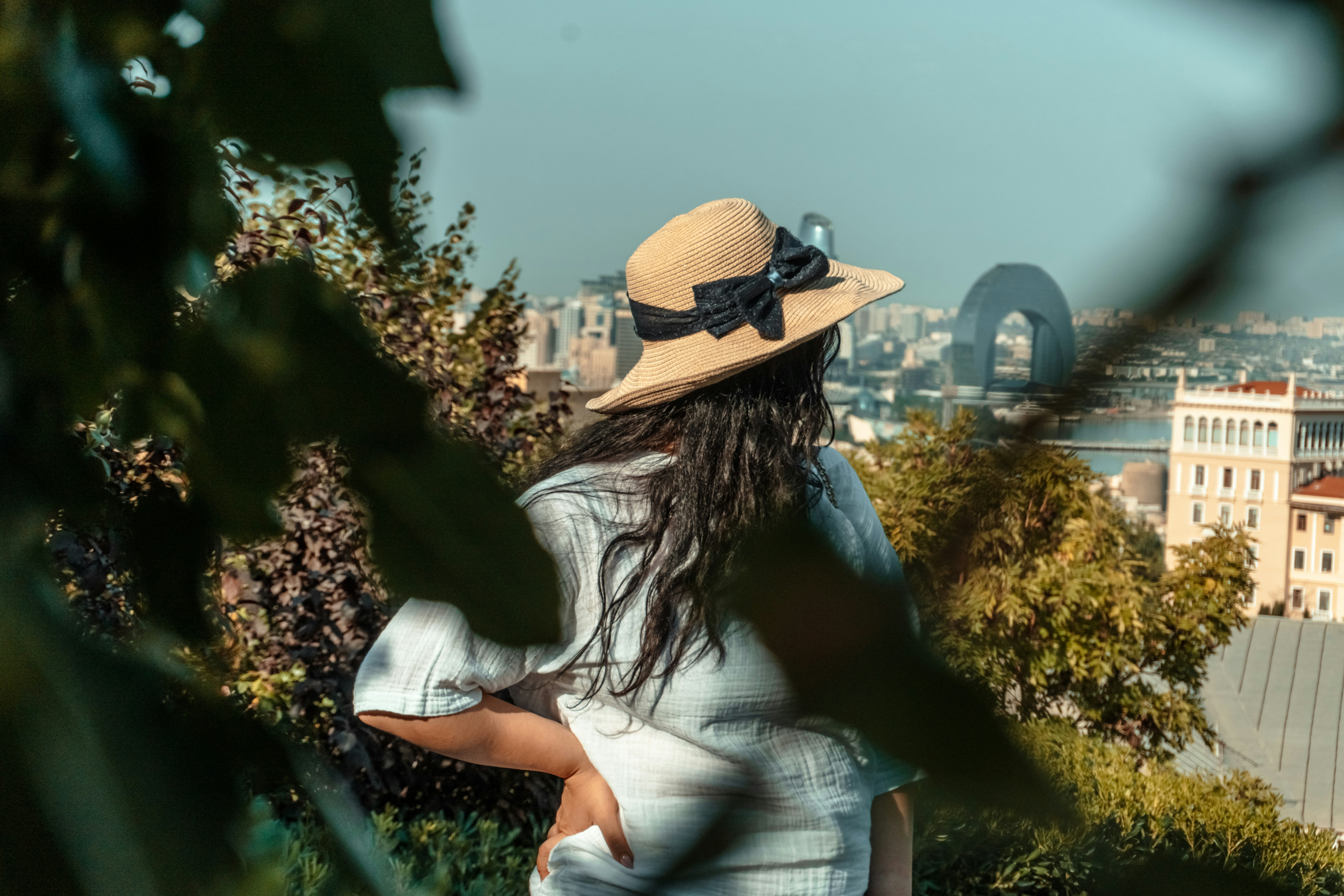 Cityscape Silhouette: A Hat, Hair, and Horizon
