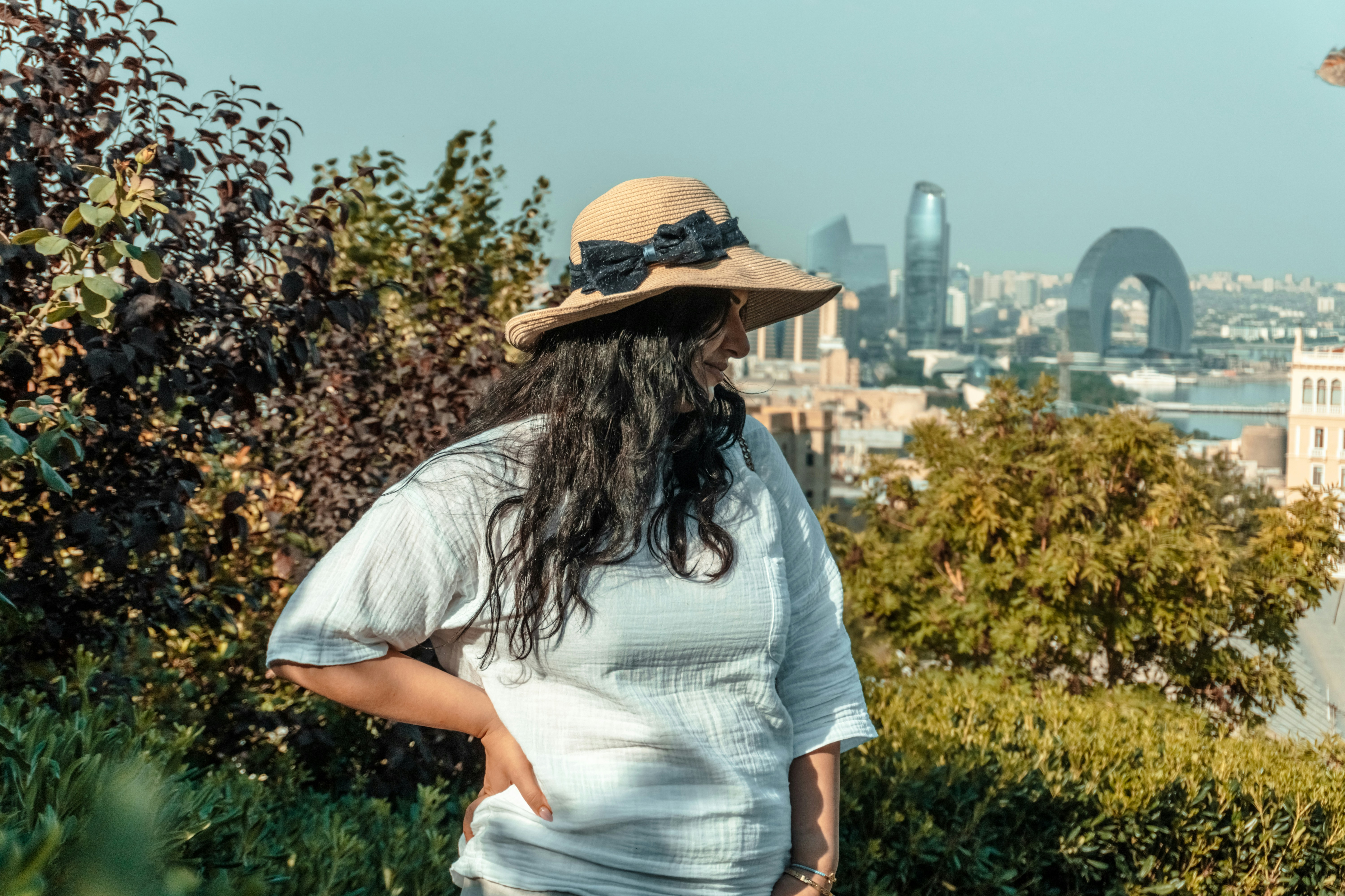 Sunlit Portrait with Urban Backdrop and Hat Silhouette