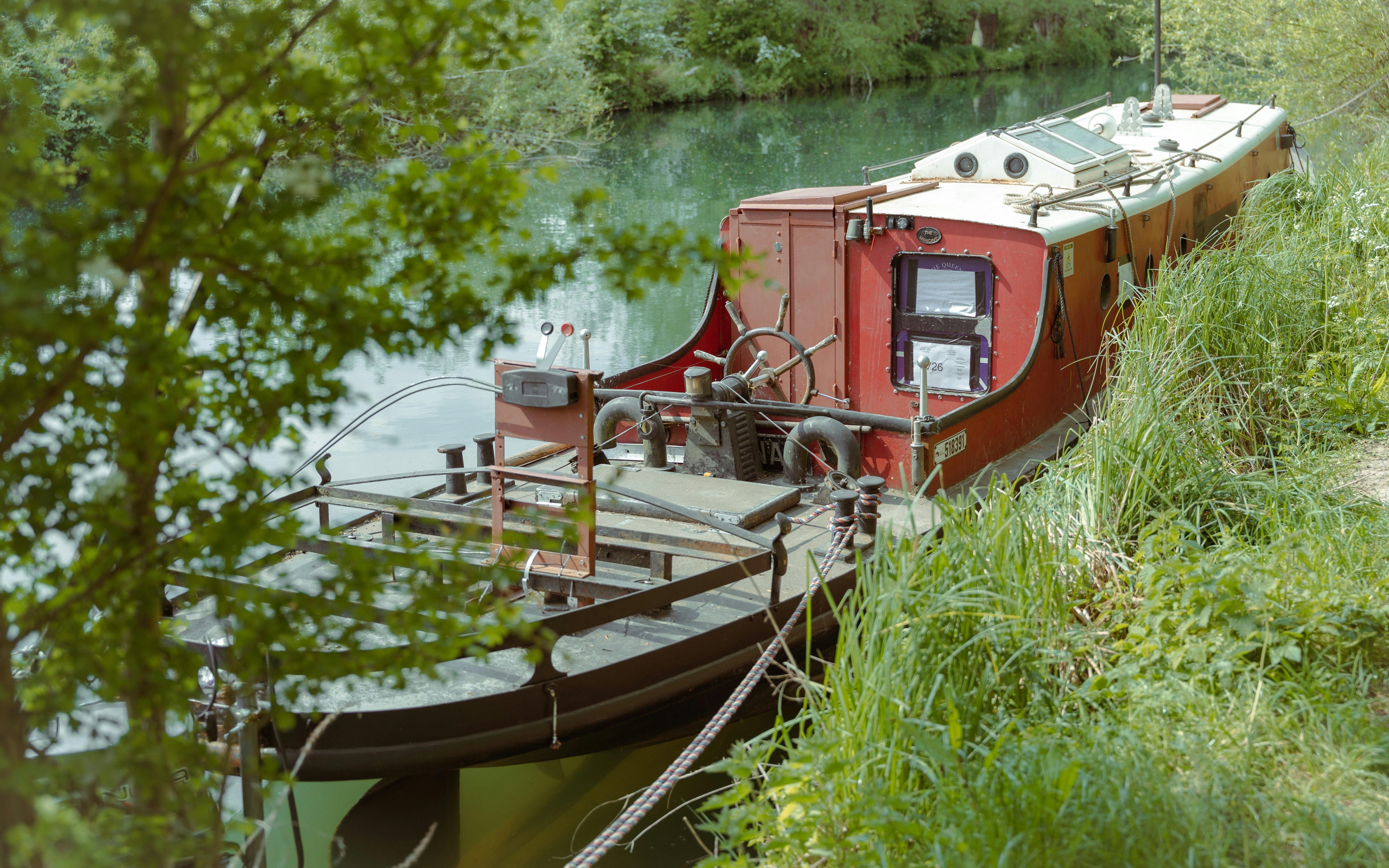 Towboat at the Verge: A Riverbound Vessel Quietly Anchored Along a Lush Bank