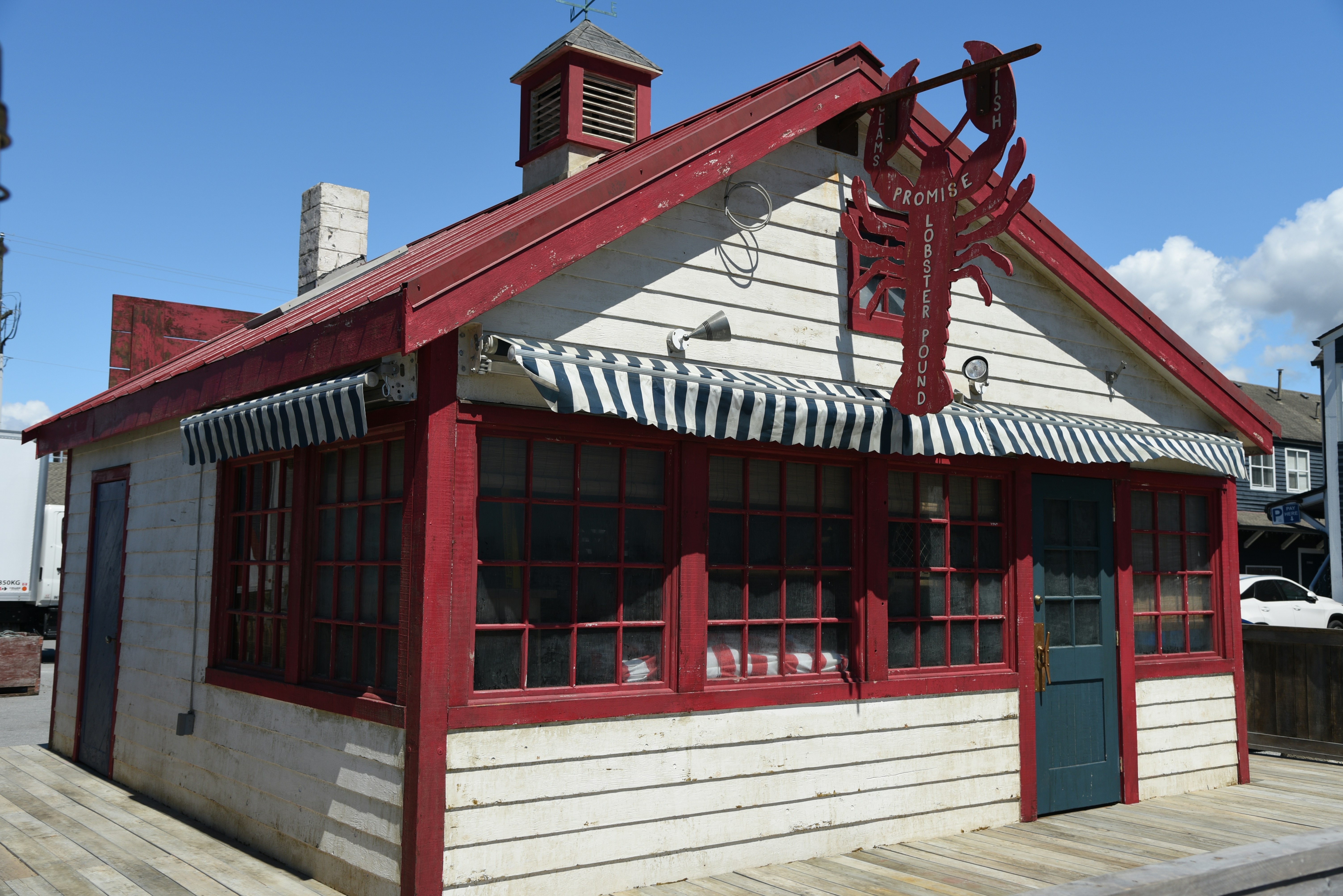 Red-and-White Corner Café with Striped Awning