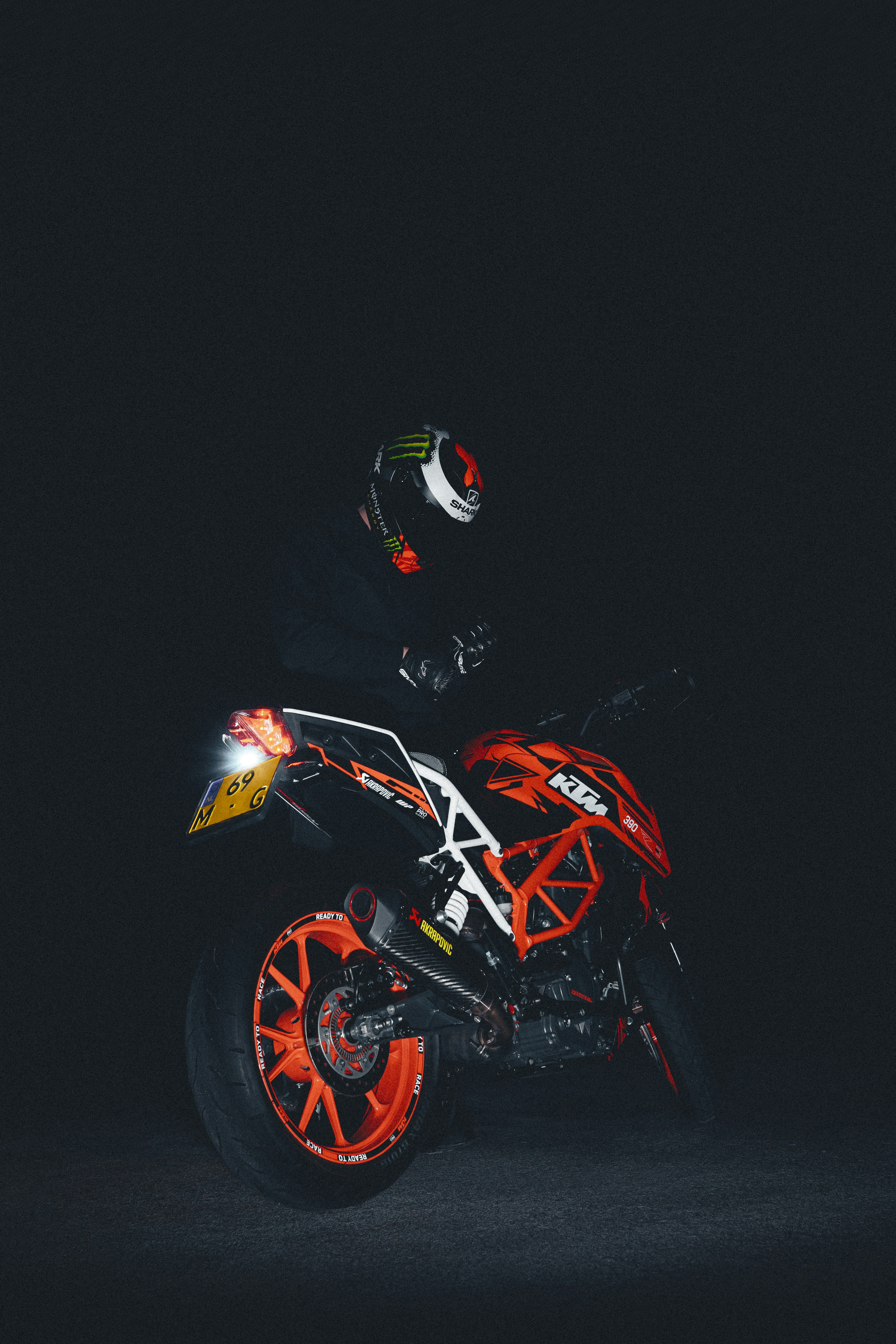 Night Ride: Red KTM Stands Out Against the Dark