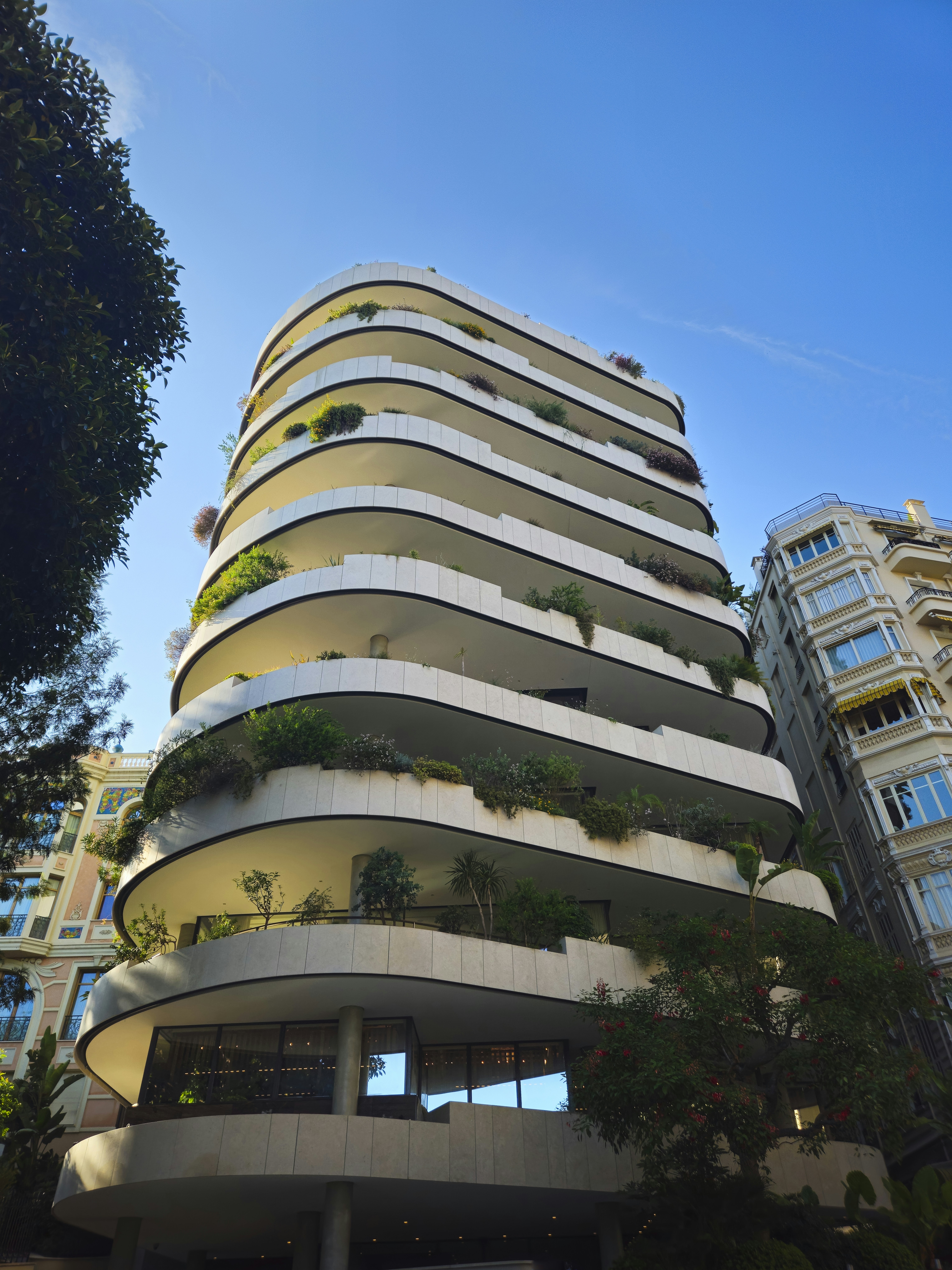 Curved Garden Tower Reaches Toward a Bright Sky