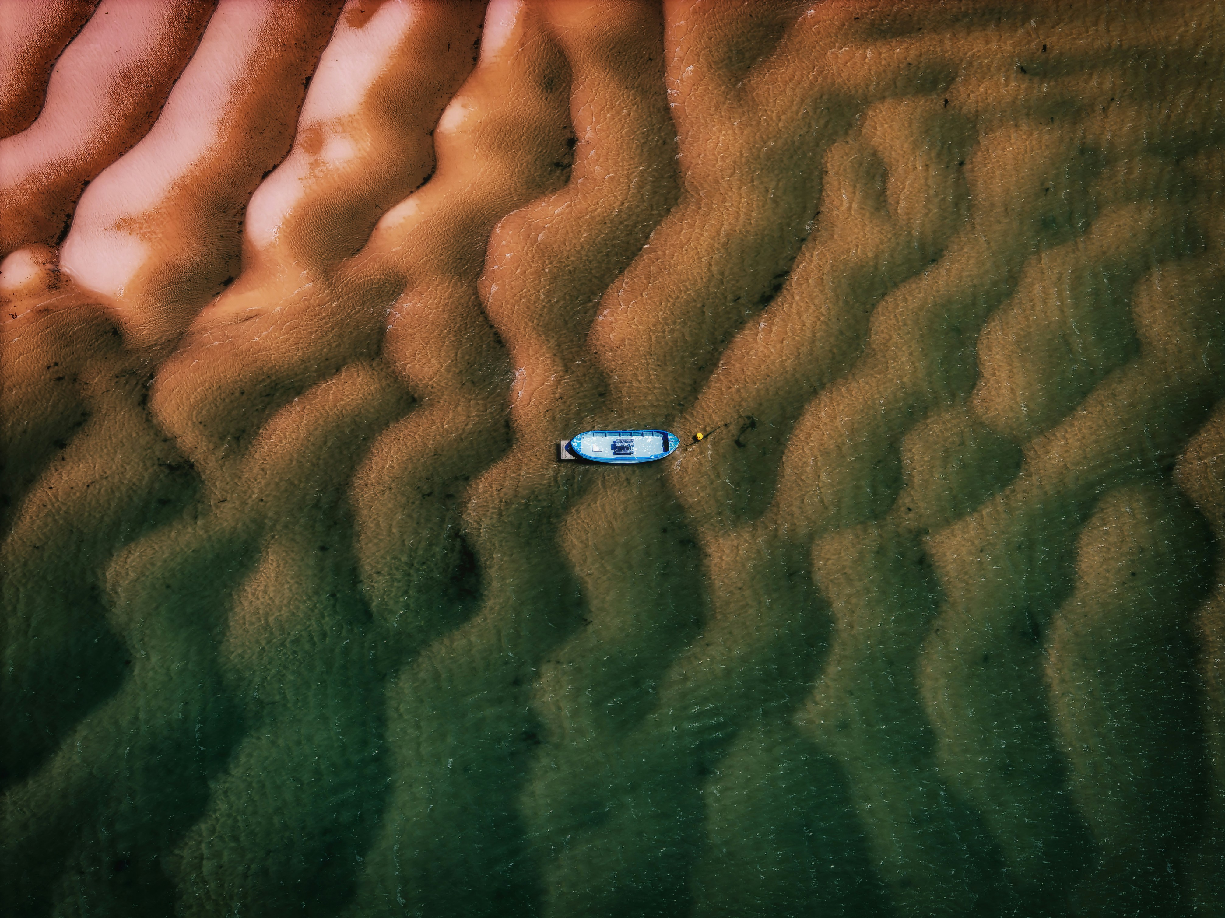 Lonely Boat Breathing in a Cresting Sea of Dunes
