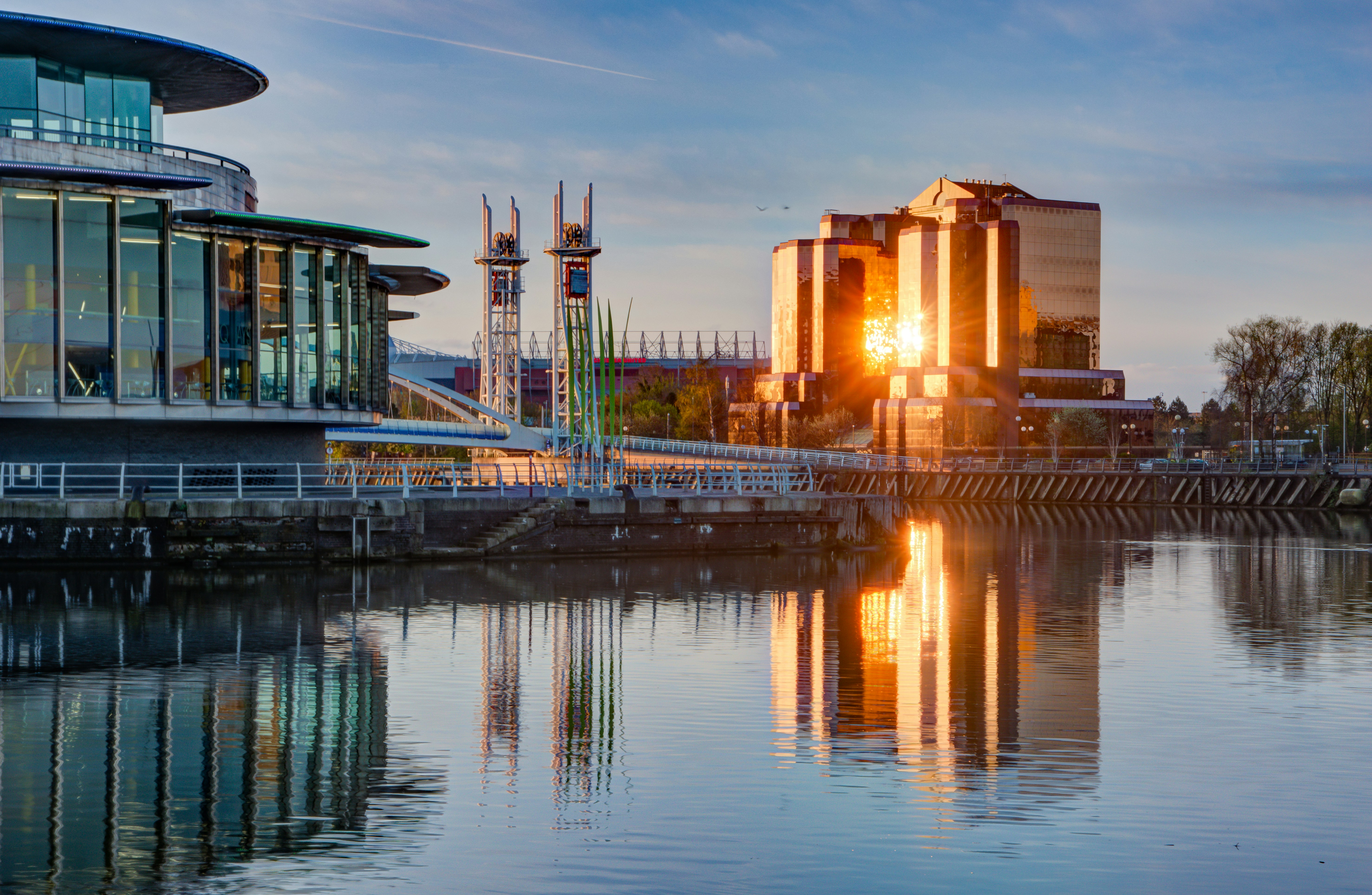 Sunlit Glass and Water: A Moment at the Riverfront