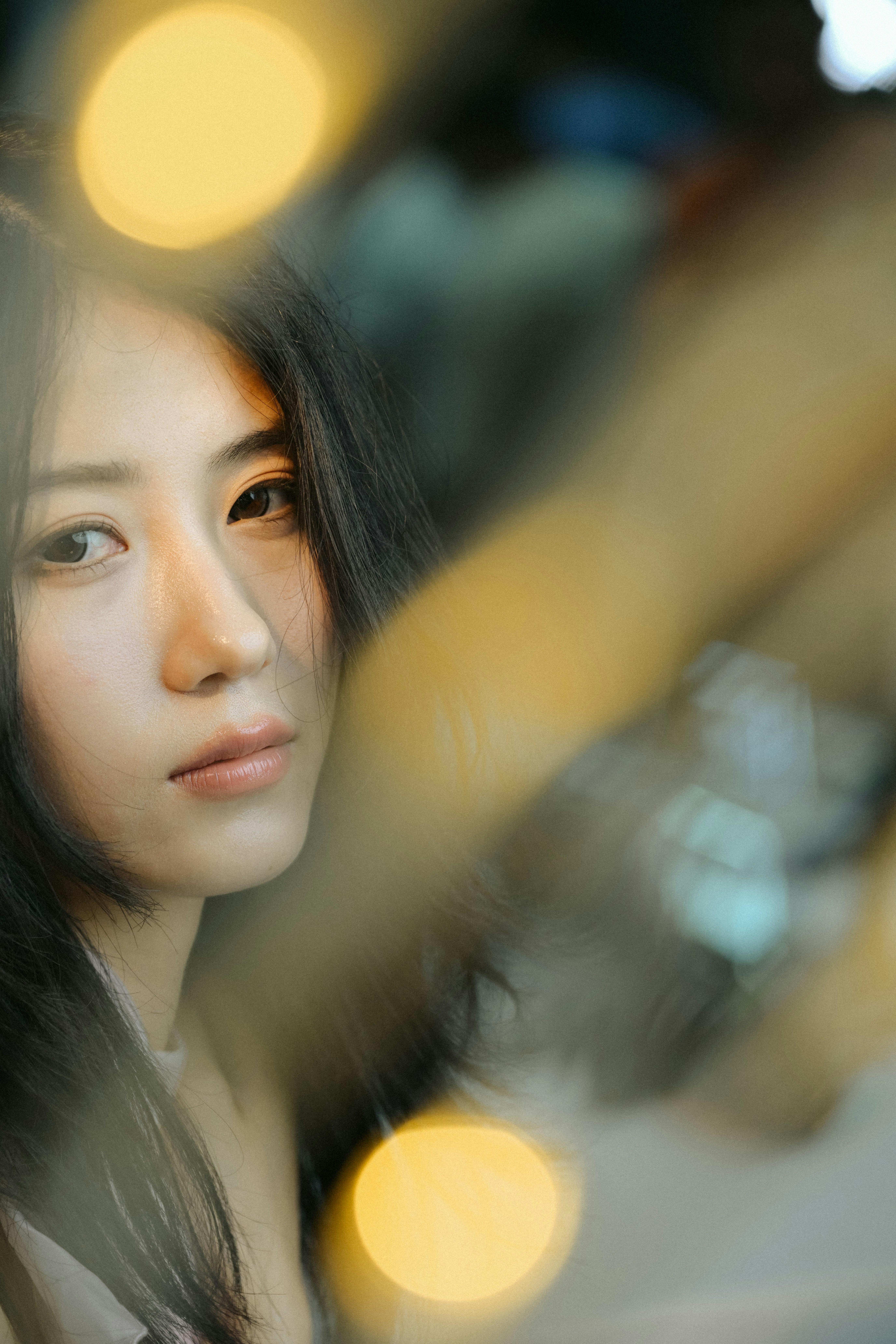 Soft Gaze Through Warm Orbs: A Quiet Portrait in Bokeh Light