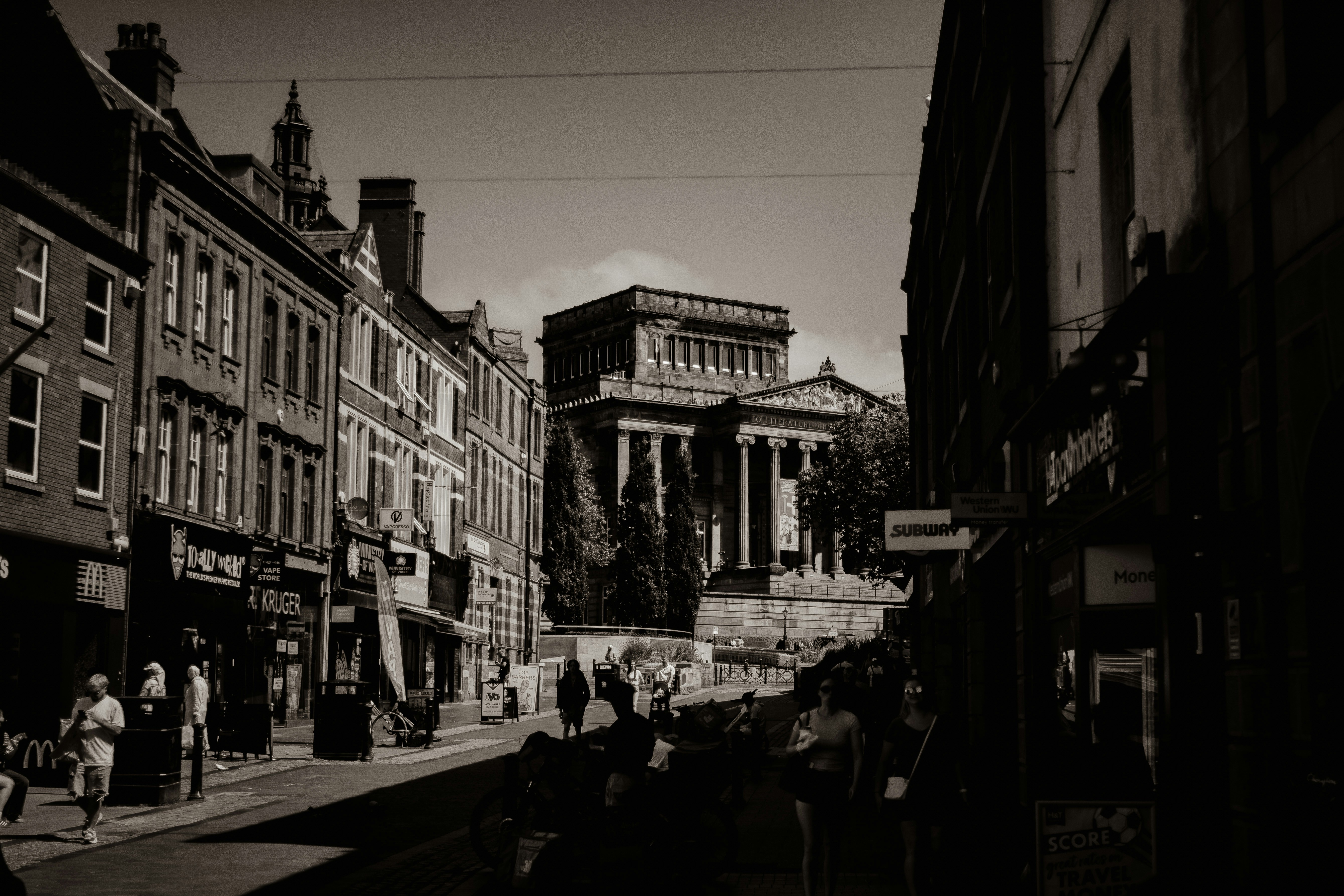 Historic Street Scene with Monumental Temple Ruins in Background