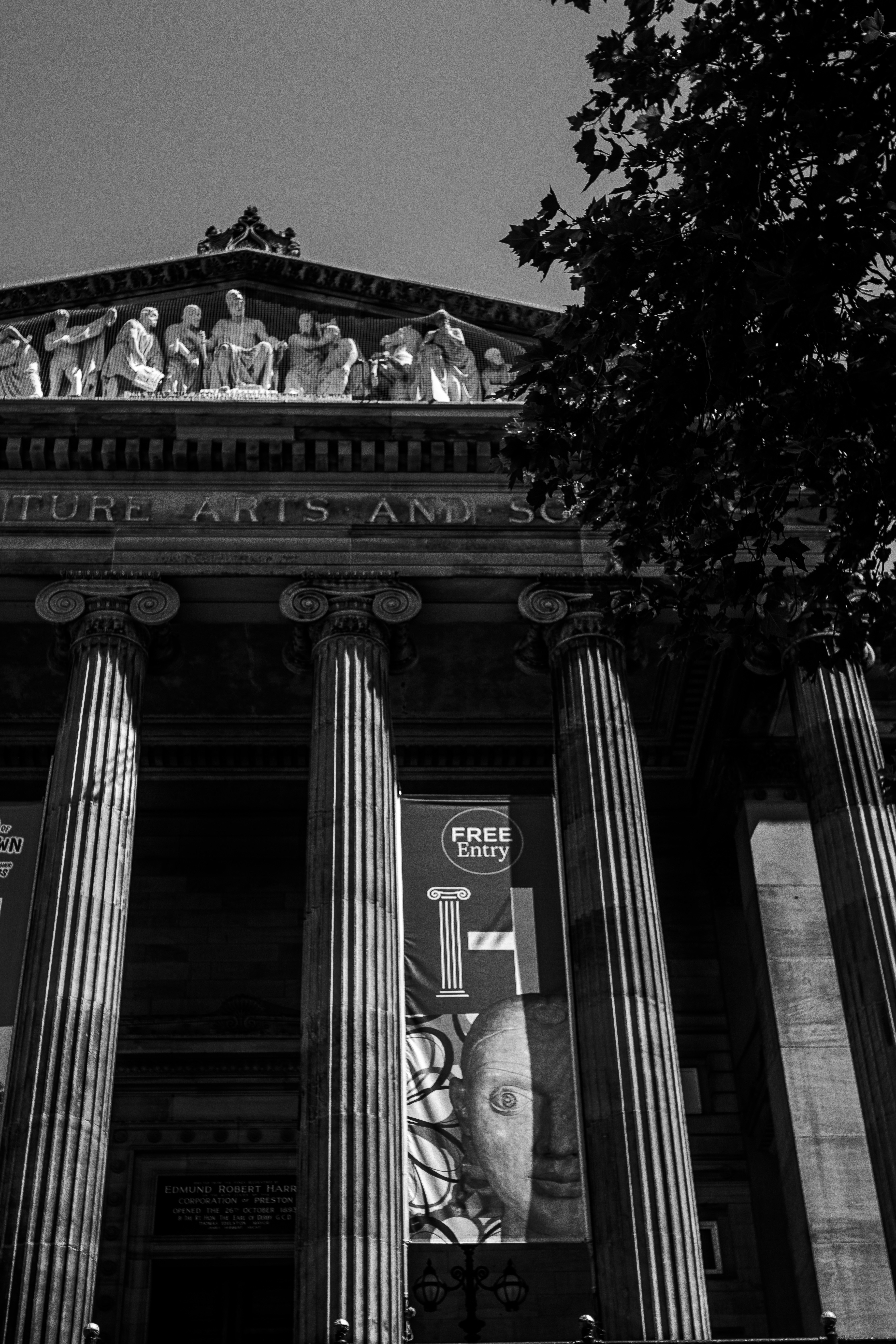 Pedimented Guardians: Blocked by Columns and Banner