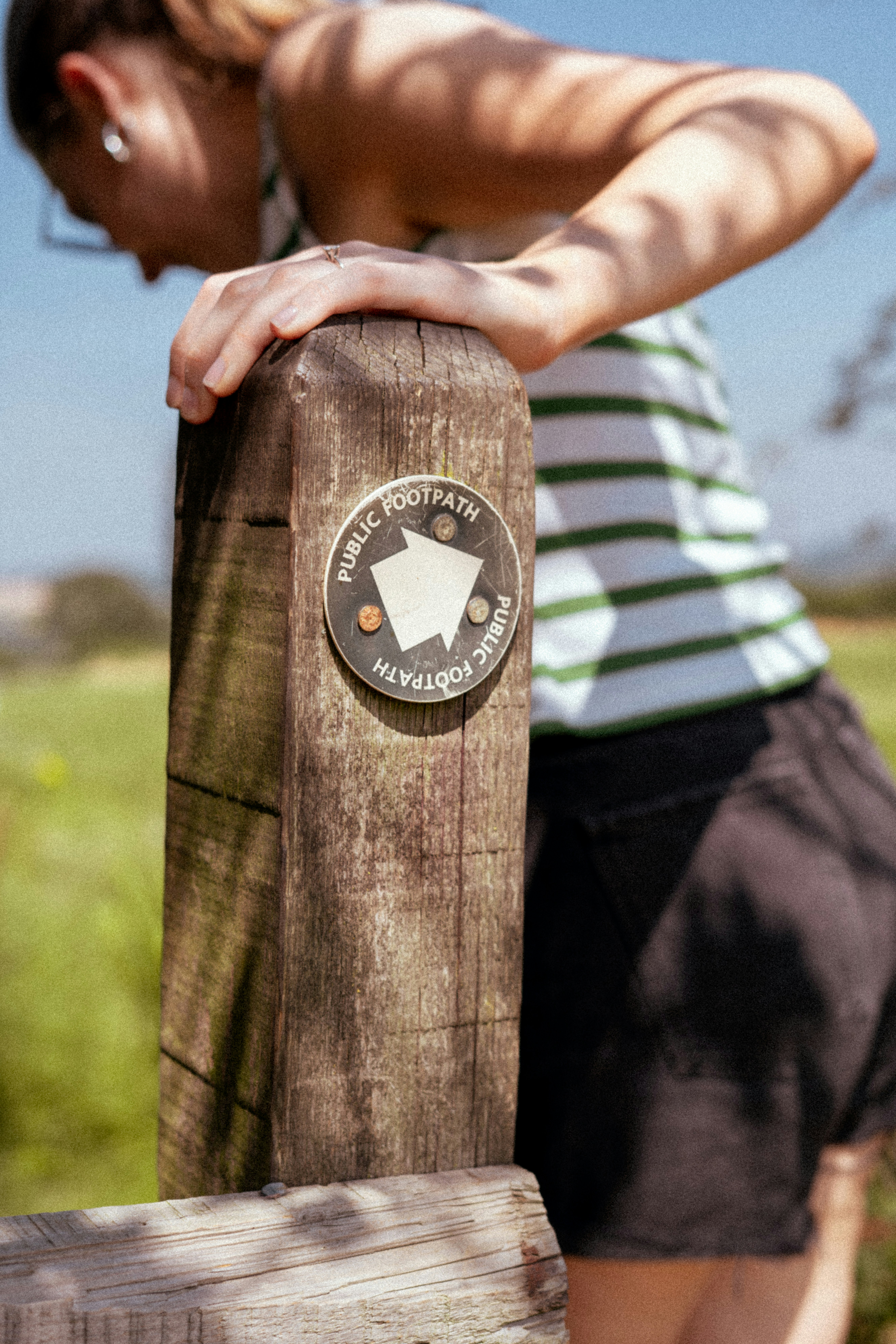 Public Footpath Marker Grips a Weathered Post