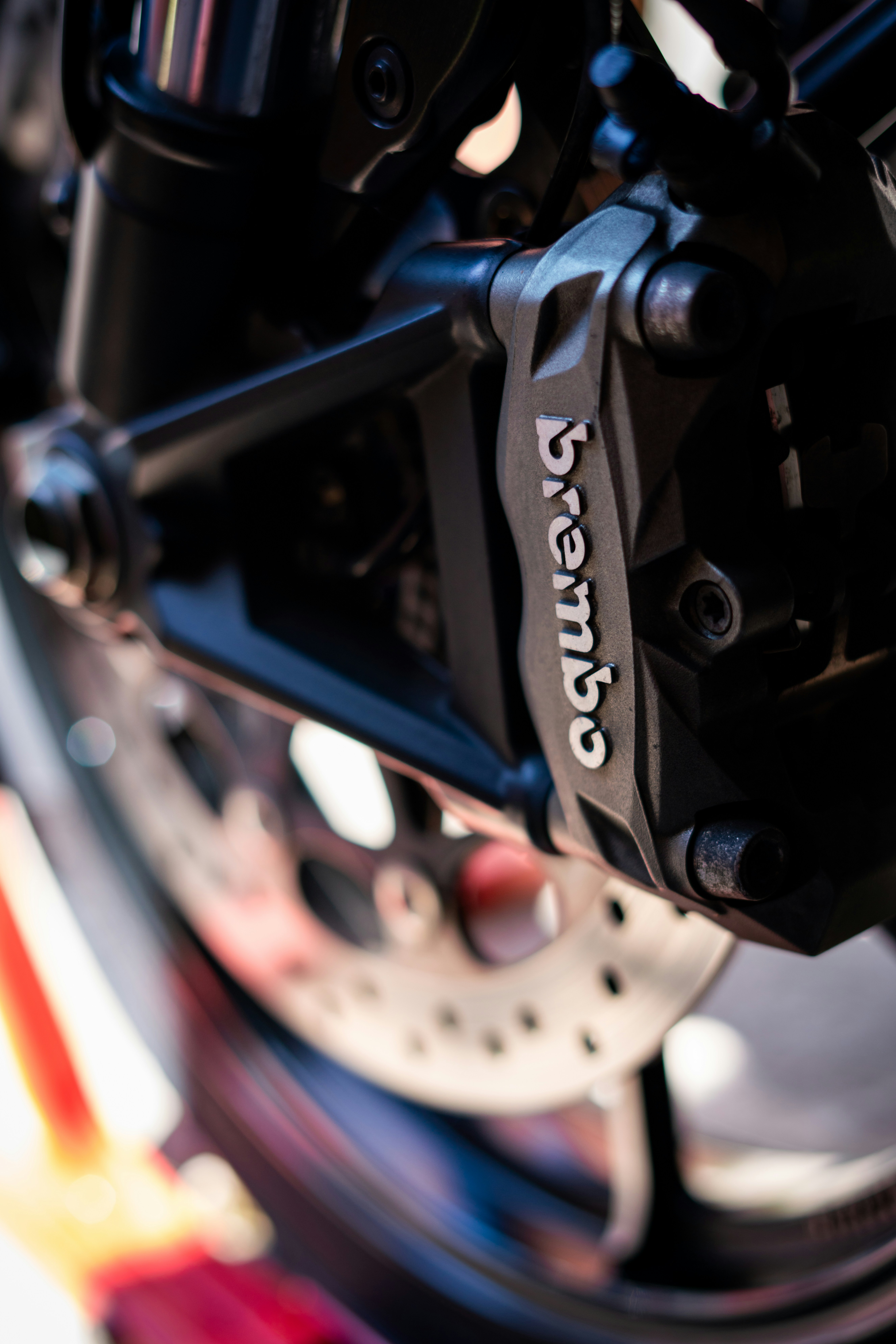 Close-up of a Brembo brake caliper: precision and power in chrome and carbon