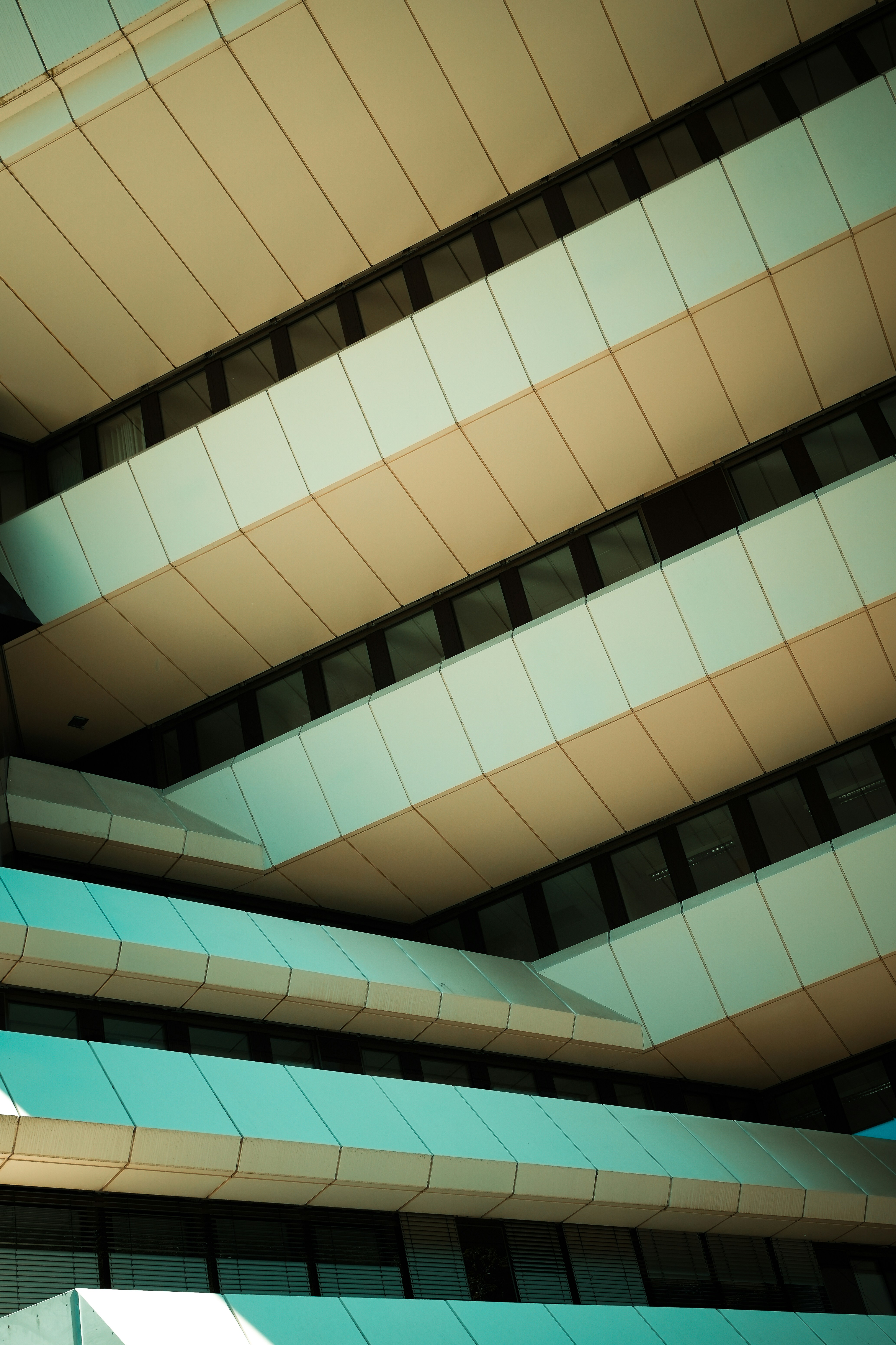 Tilted Strata: Diagonal Facade Layers in Muted Teal and Sand
