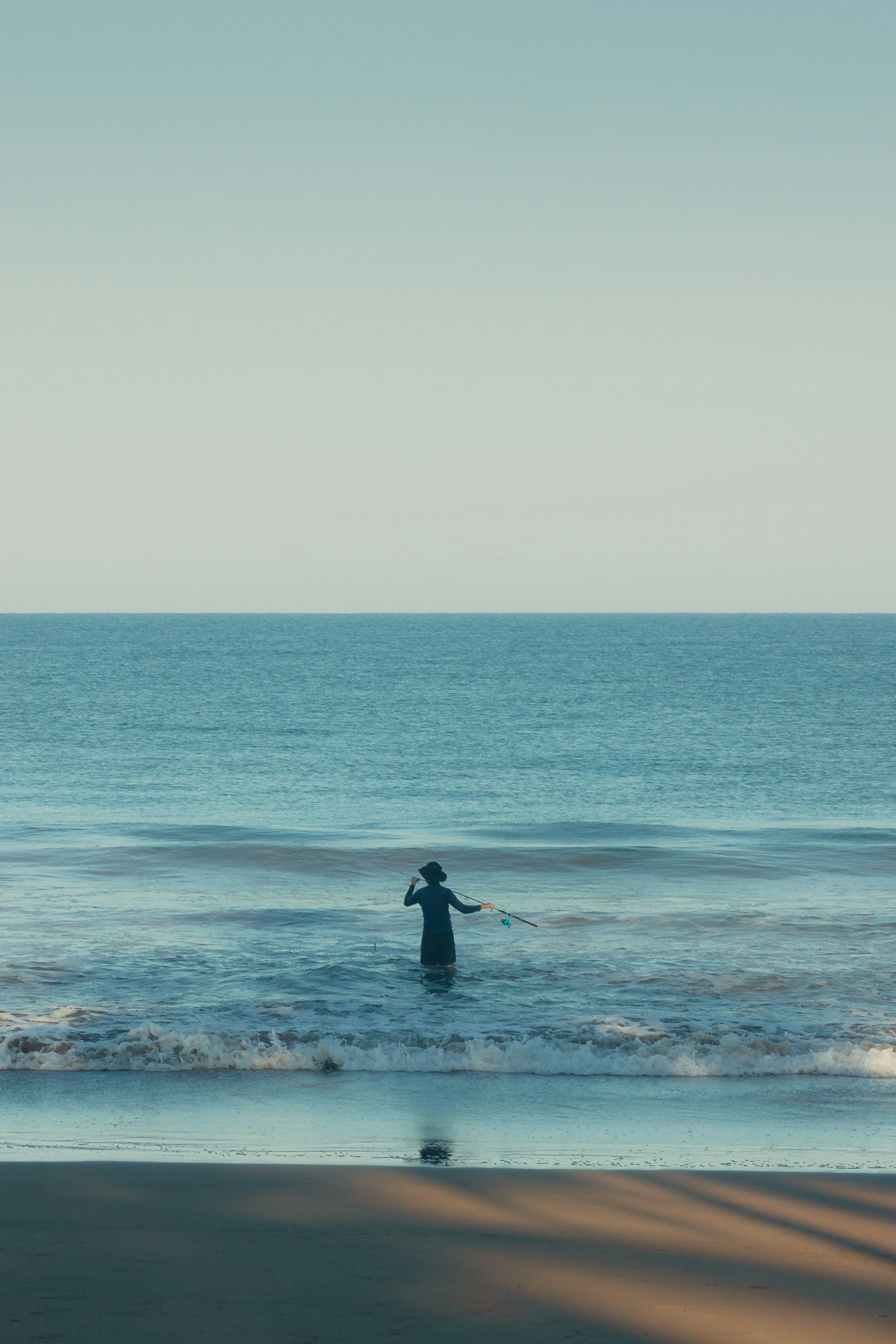 Shadowed Surfer in Quiet Atlantic