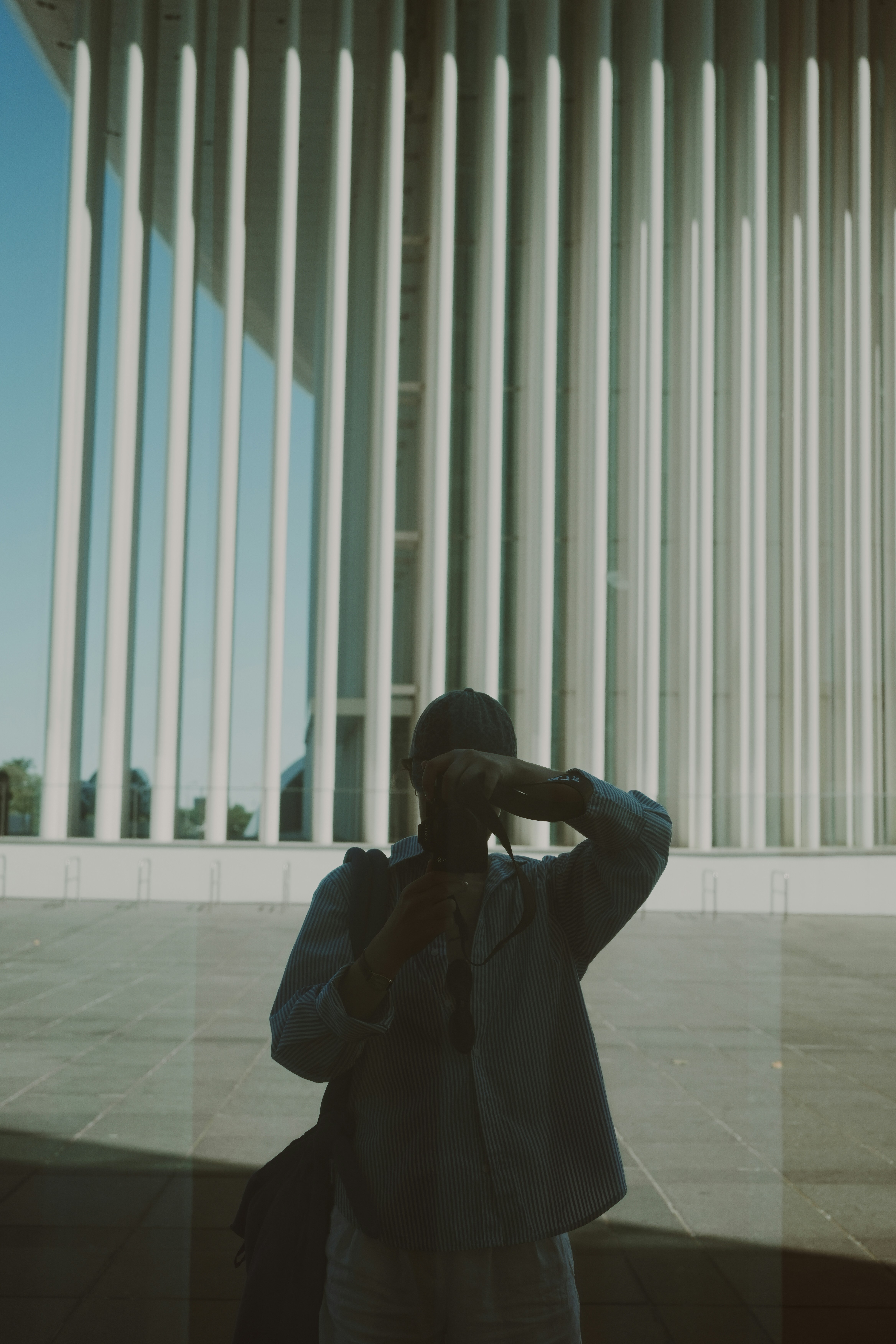 Reflective Portrait in Front of Vertical Lines