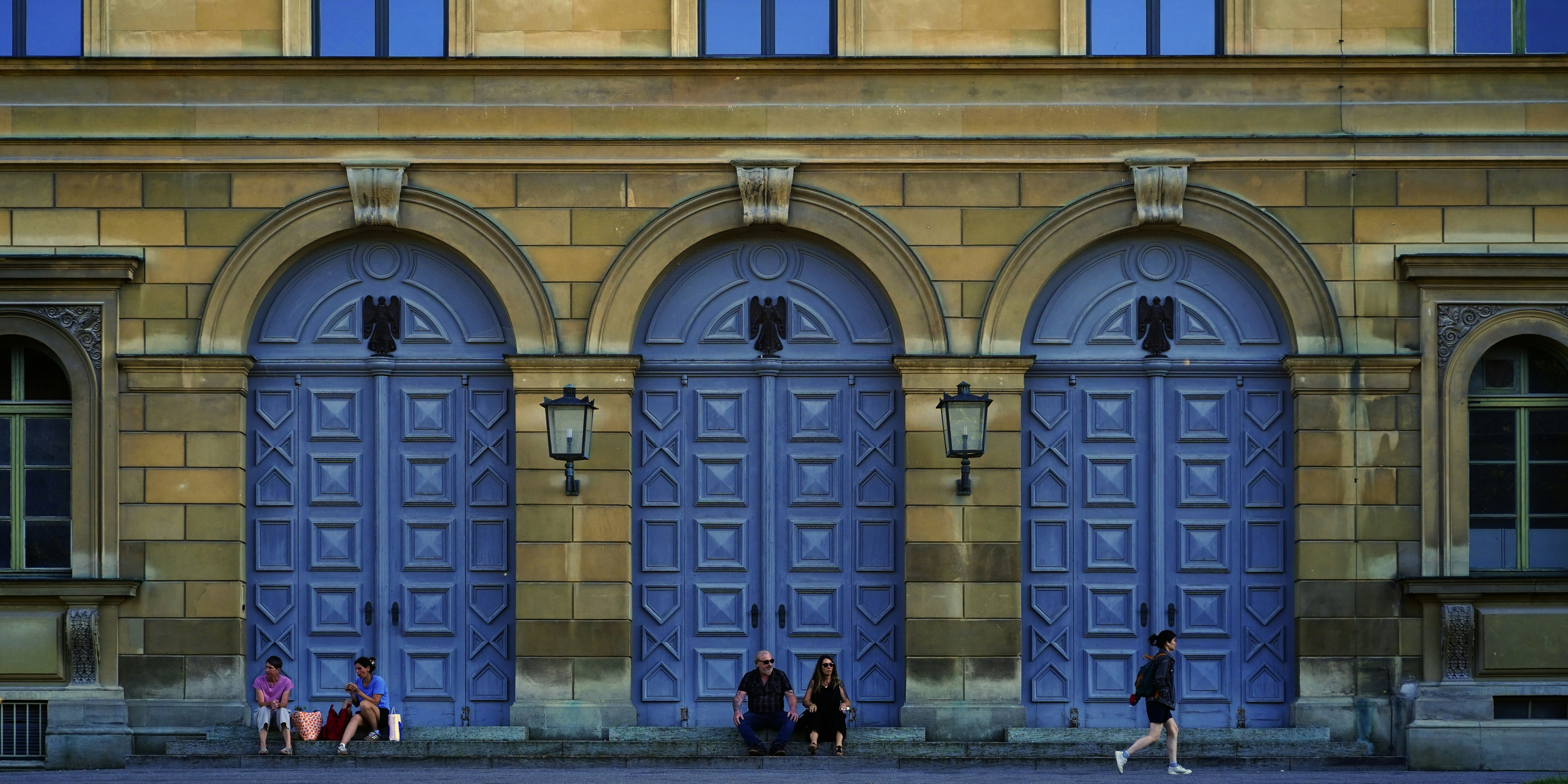 Blue Doors, Stone Facade: Quiet Moments Along a Historic Stoa