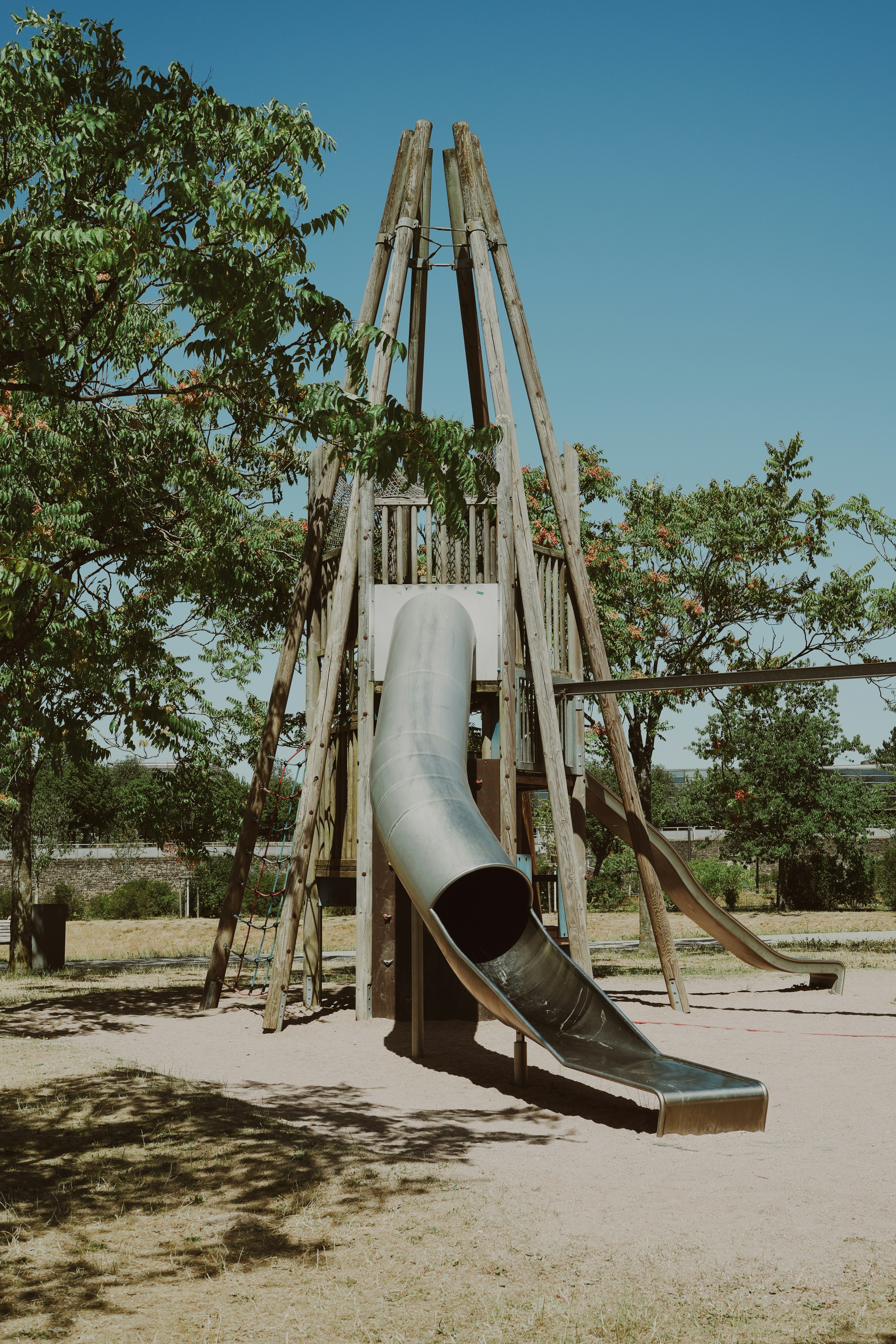 Playground Tower: A Slide of Steel Under Noon Light