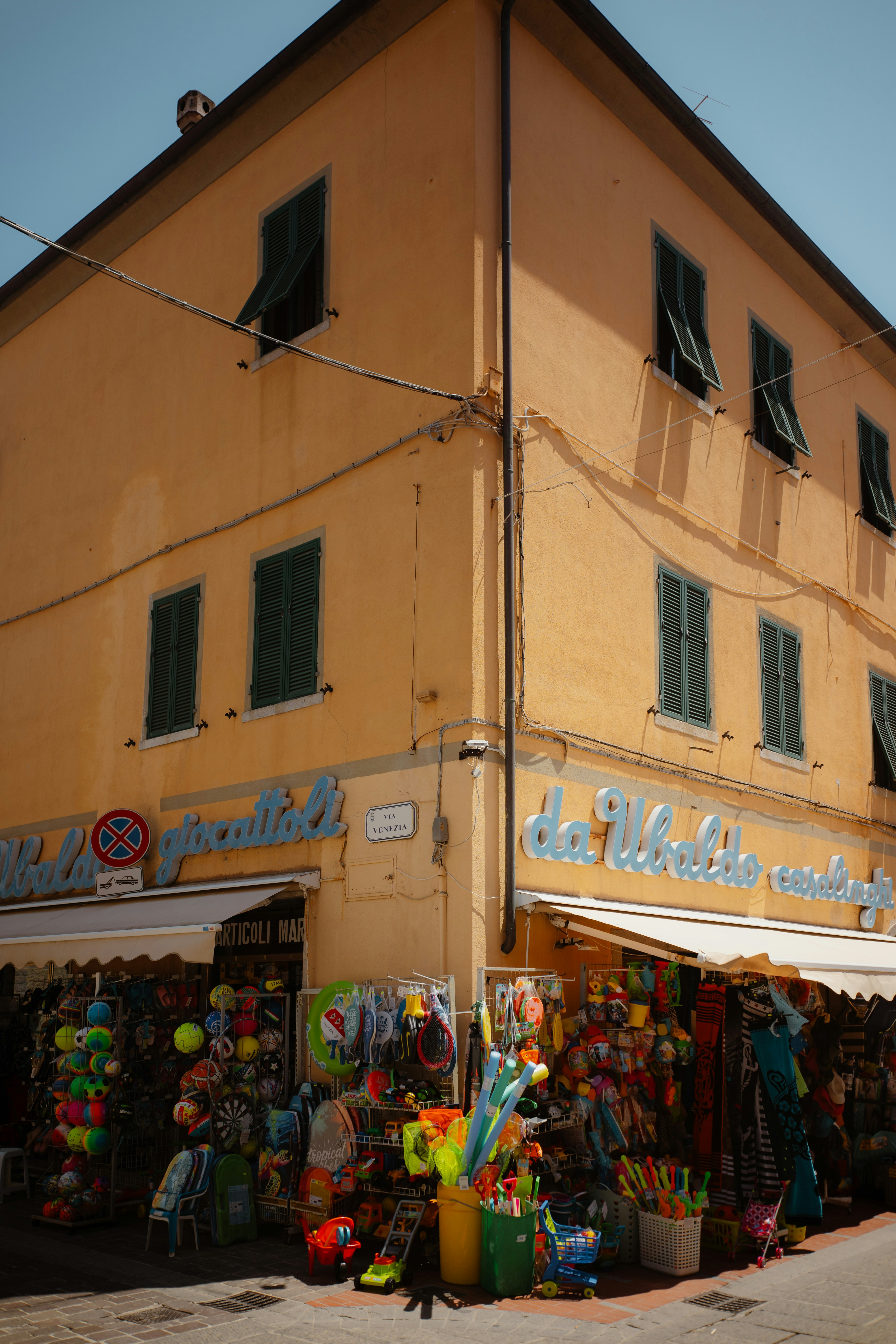 Sunny Corner Shopfront on a Warm Italian Street