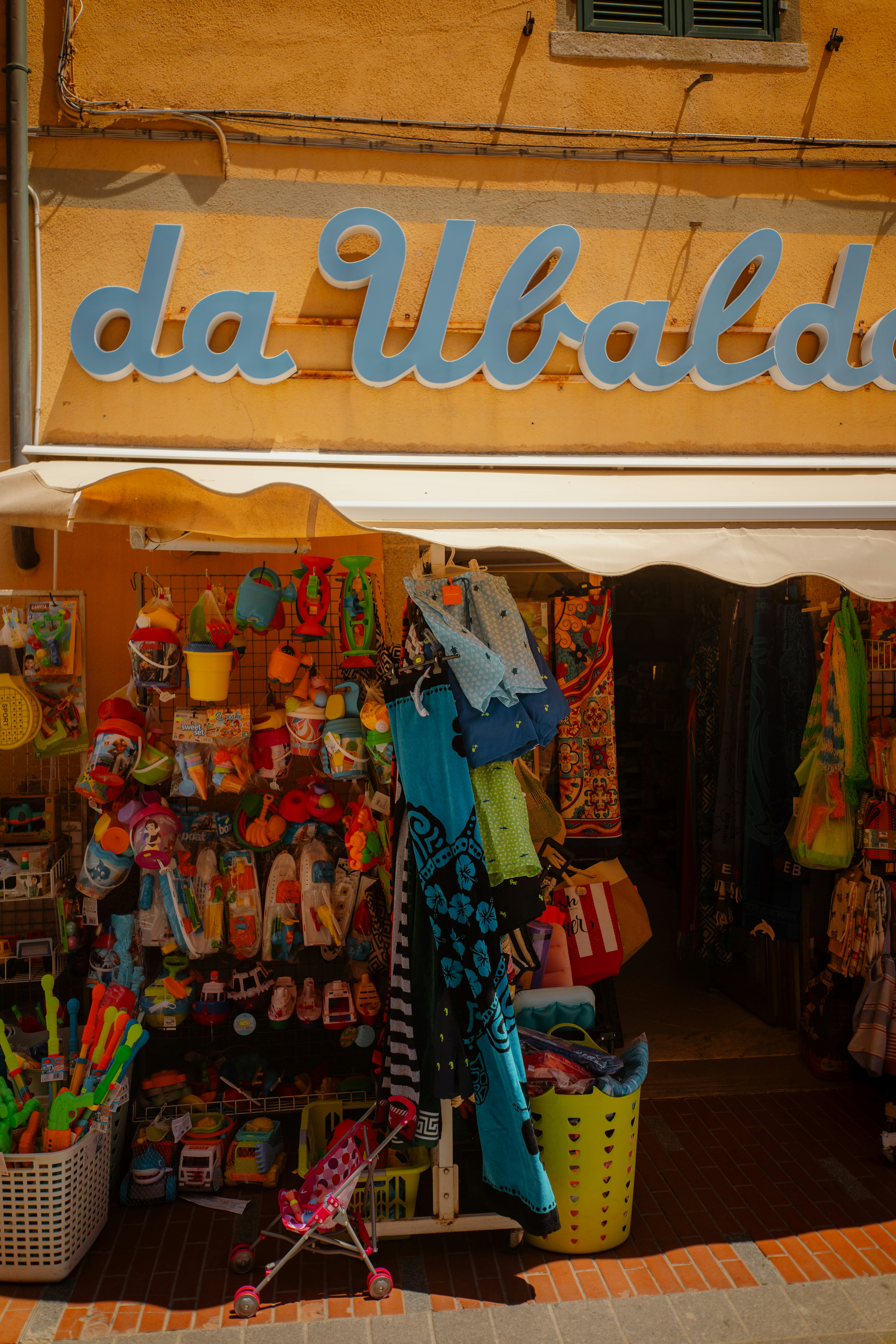 Sunlit Boutique Bazaar Under a Lime Sign