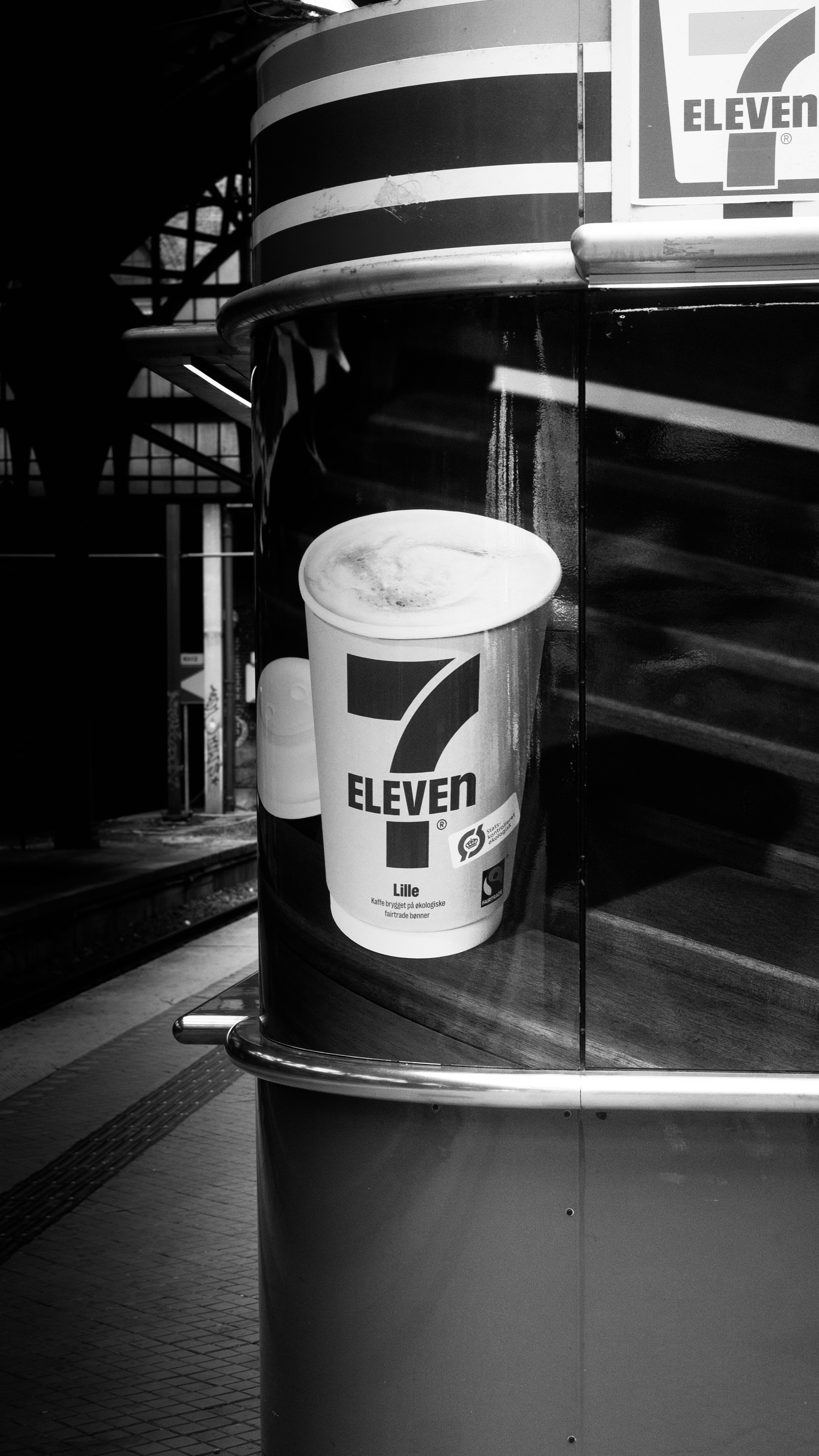 Cafe Cup on a Grimy Outpost: A Black-and-White Moment at the Station