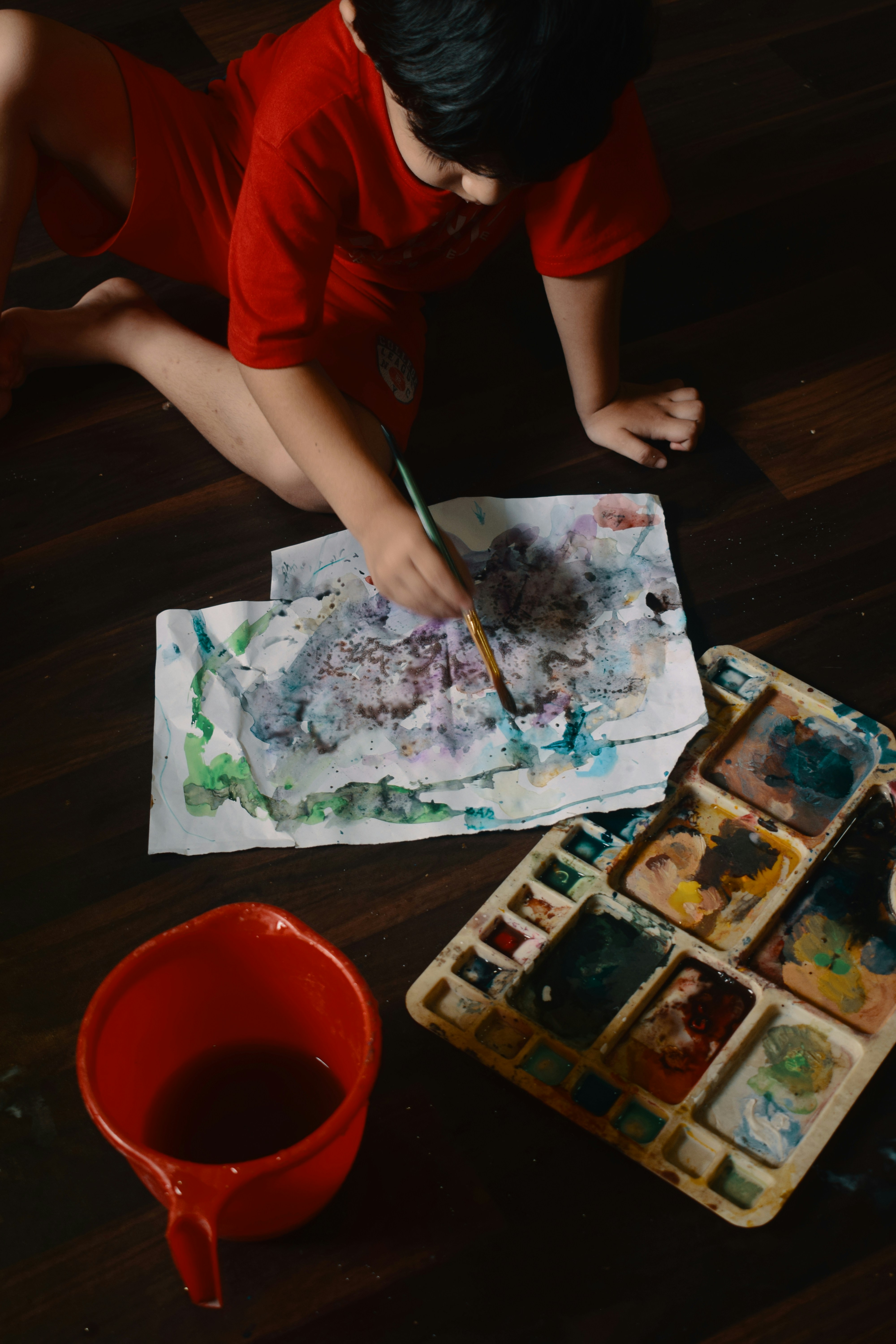 Young Artist at Work: Colors Splash Across Paper