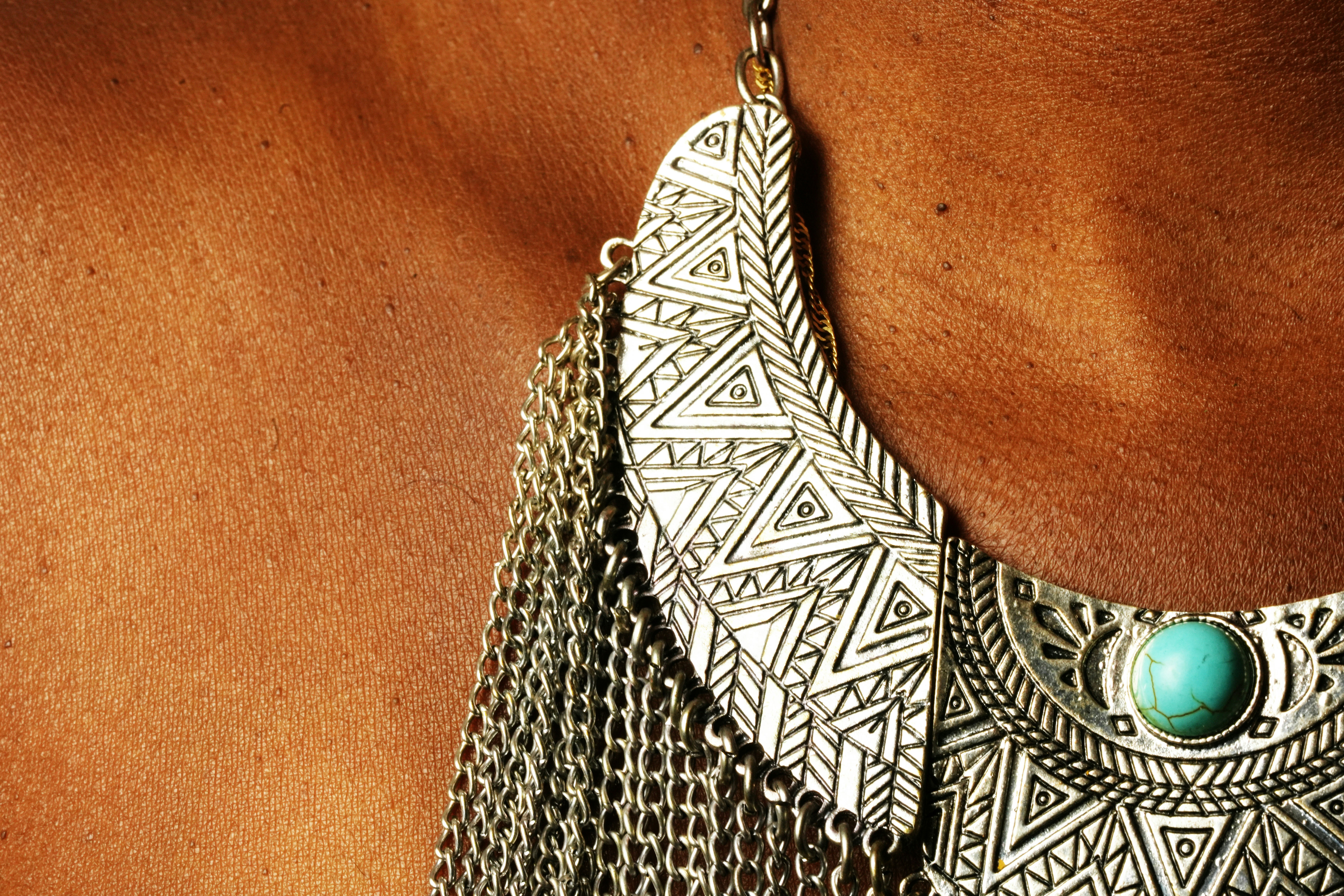 Silver Necklace Echoes Across Tan Skin