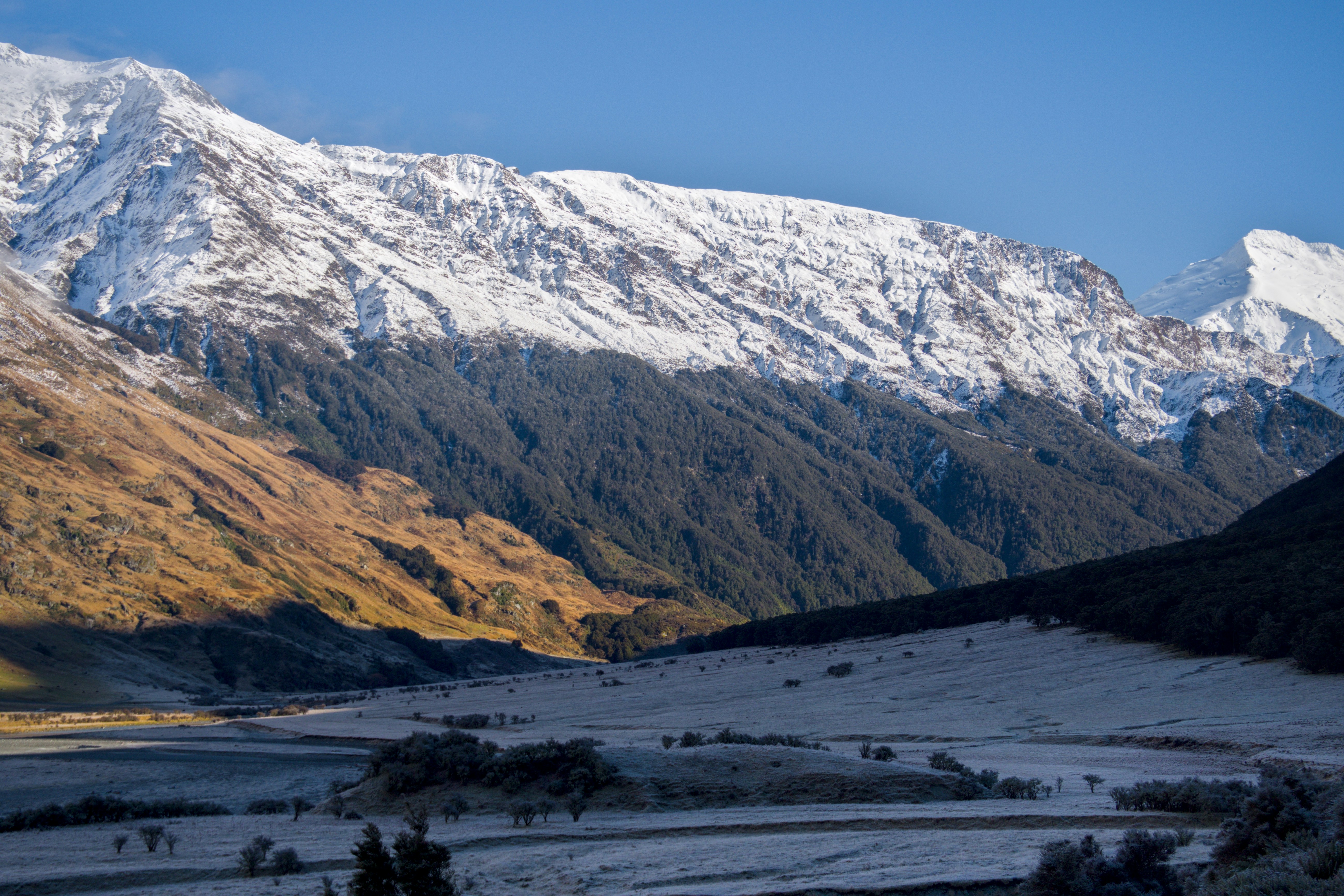 Snow‑capped Giants Beyond the Golden Valley