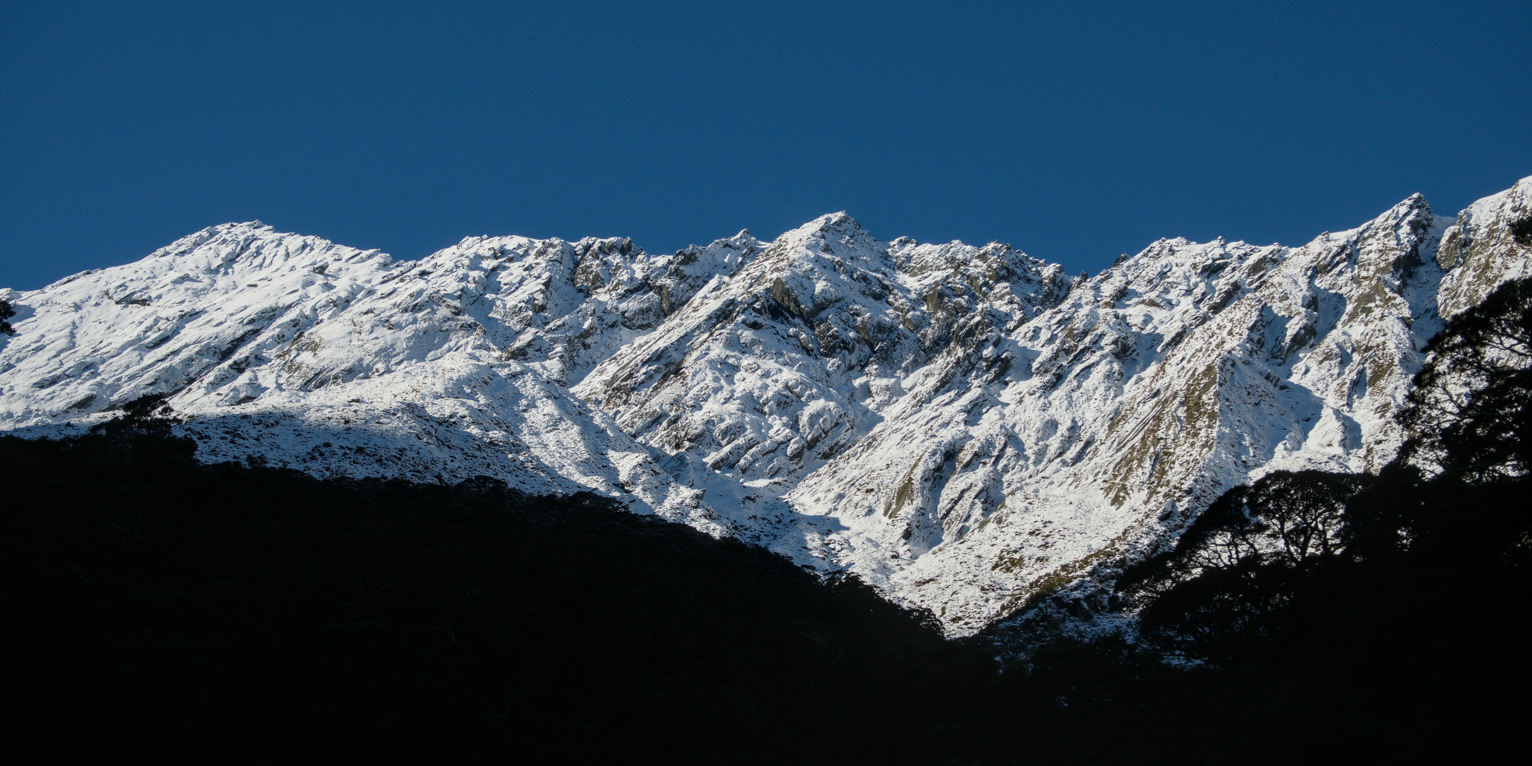 Snow-Kissed Ridge Under a Clear Azure Sky