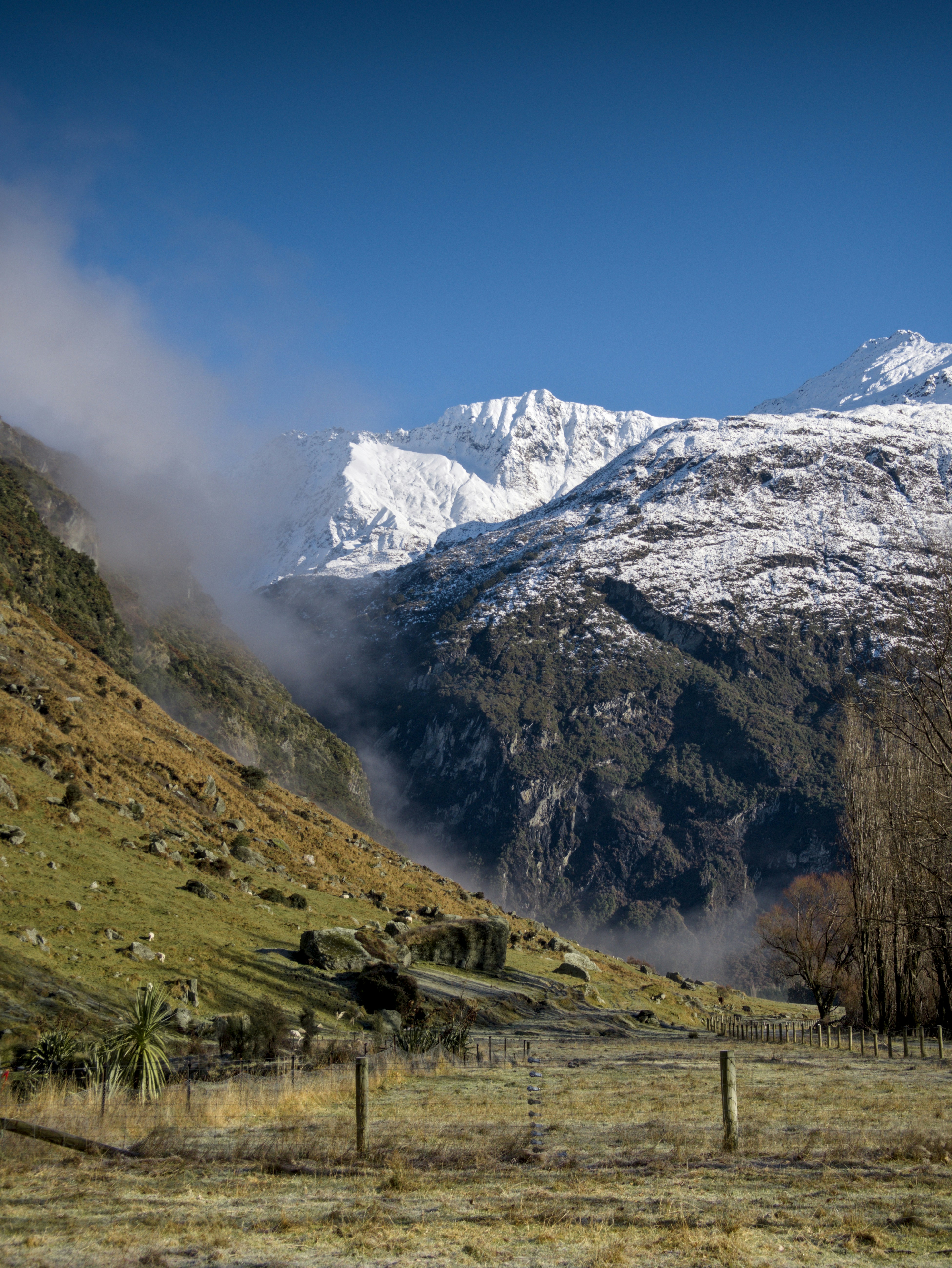 Snow-kissed Peaks Over a Misty Valleyscape