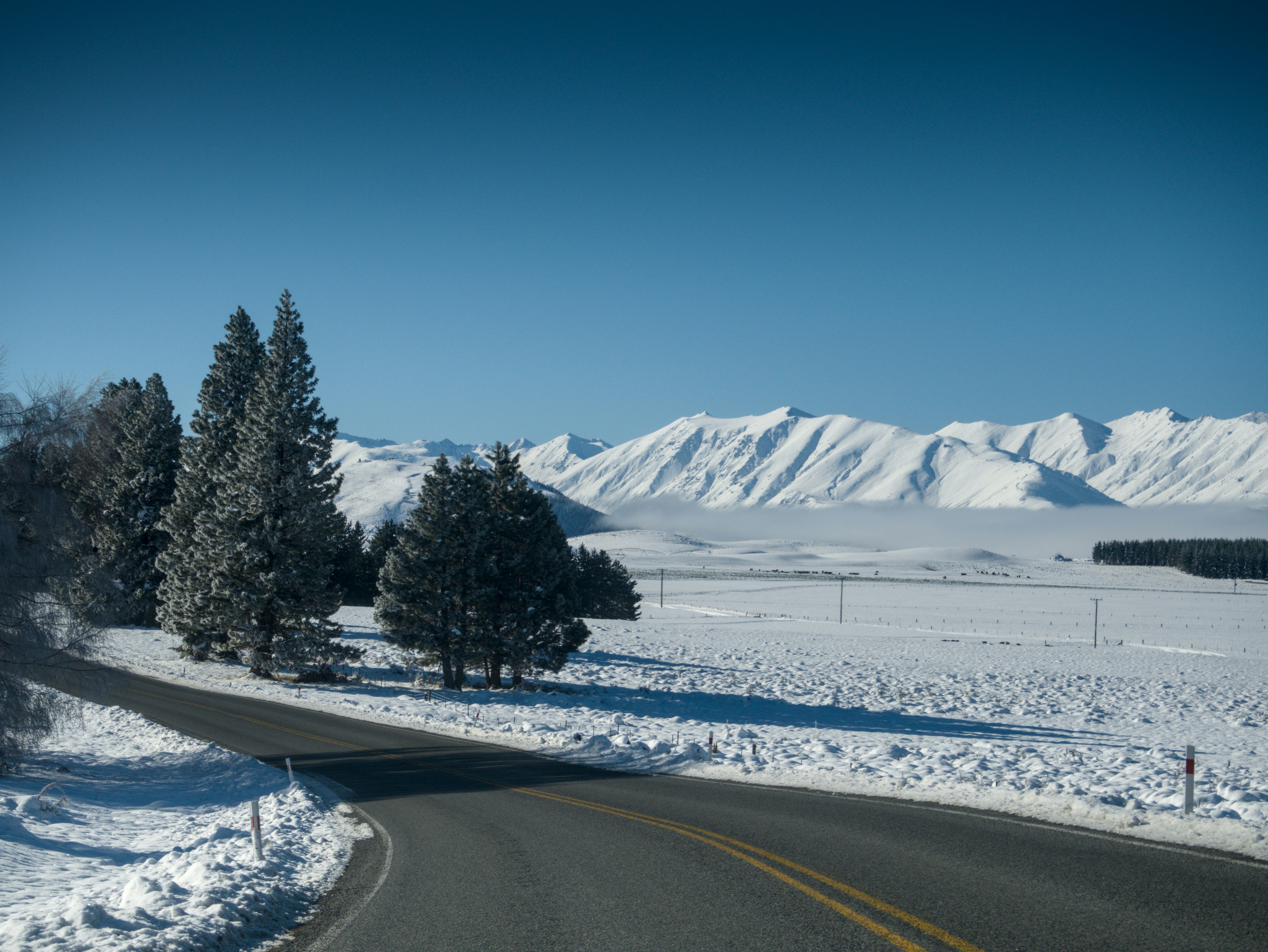 Snowbound Curve: A Quiet Road Beneath Alpine Peaks