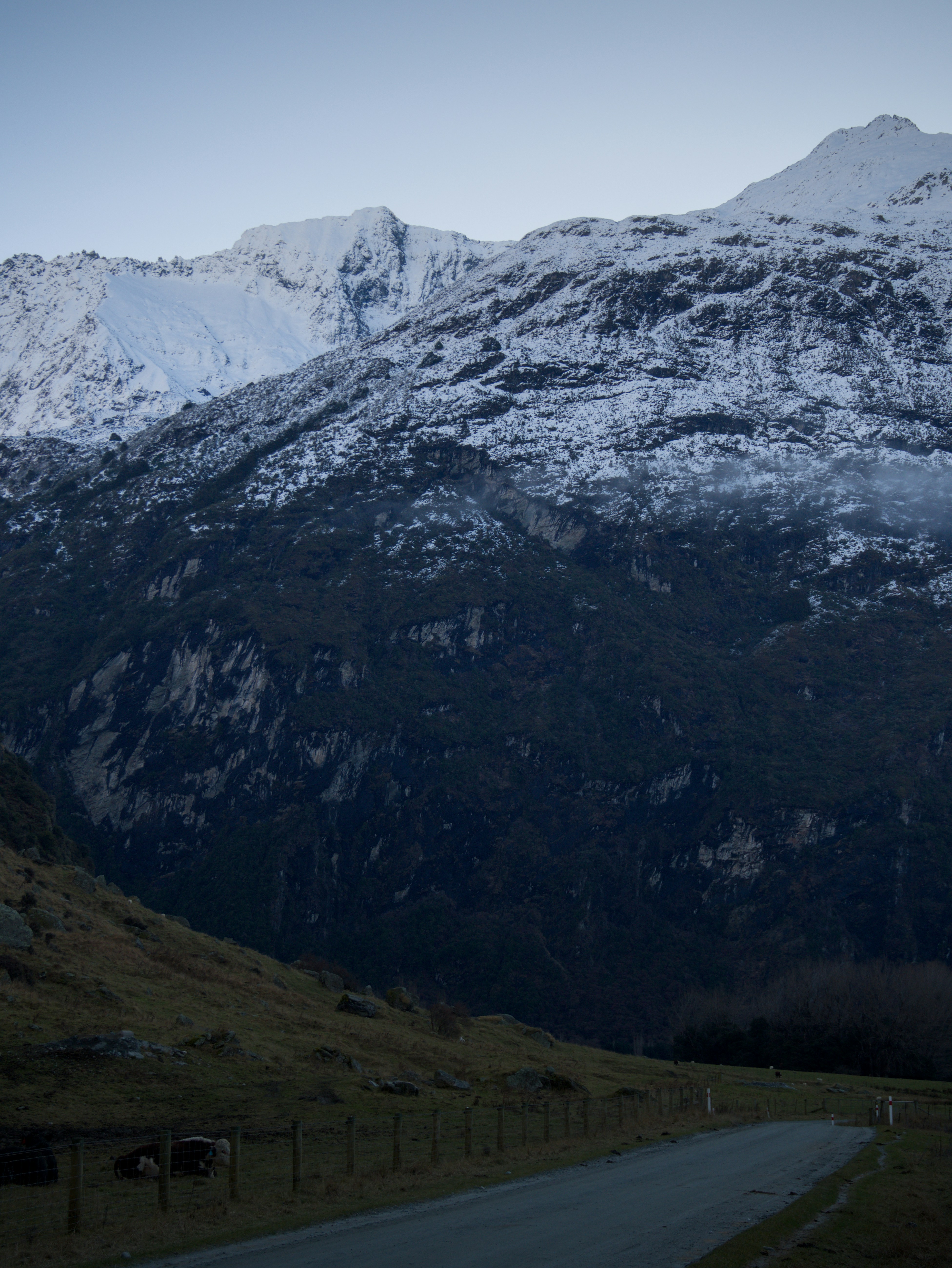 Snow-dusted Peaks Over a Quiet Valley Road