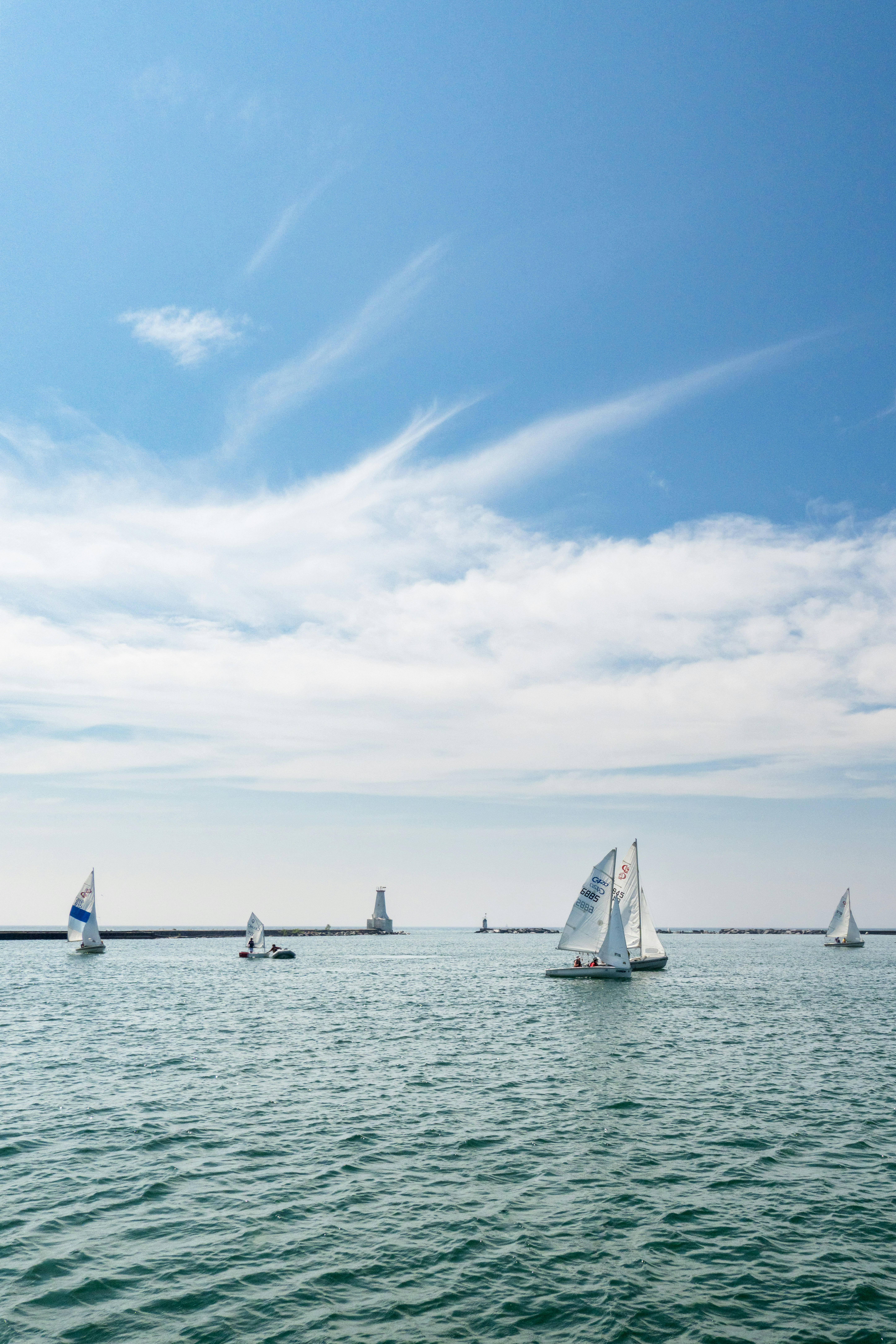 Sailboats on a Calm Horizon under Wide Blue Sky