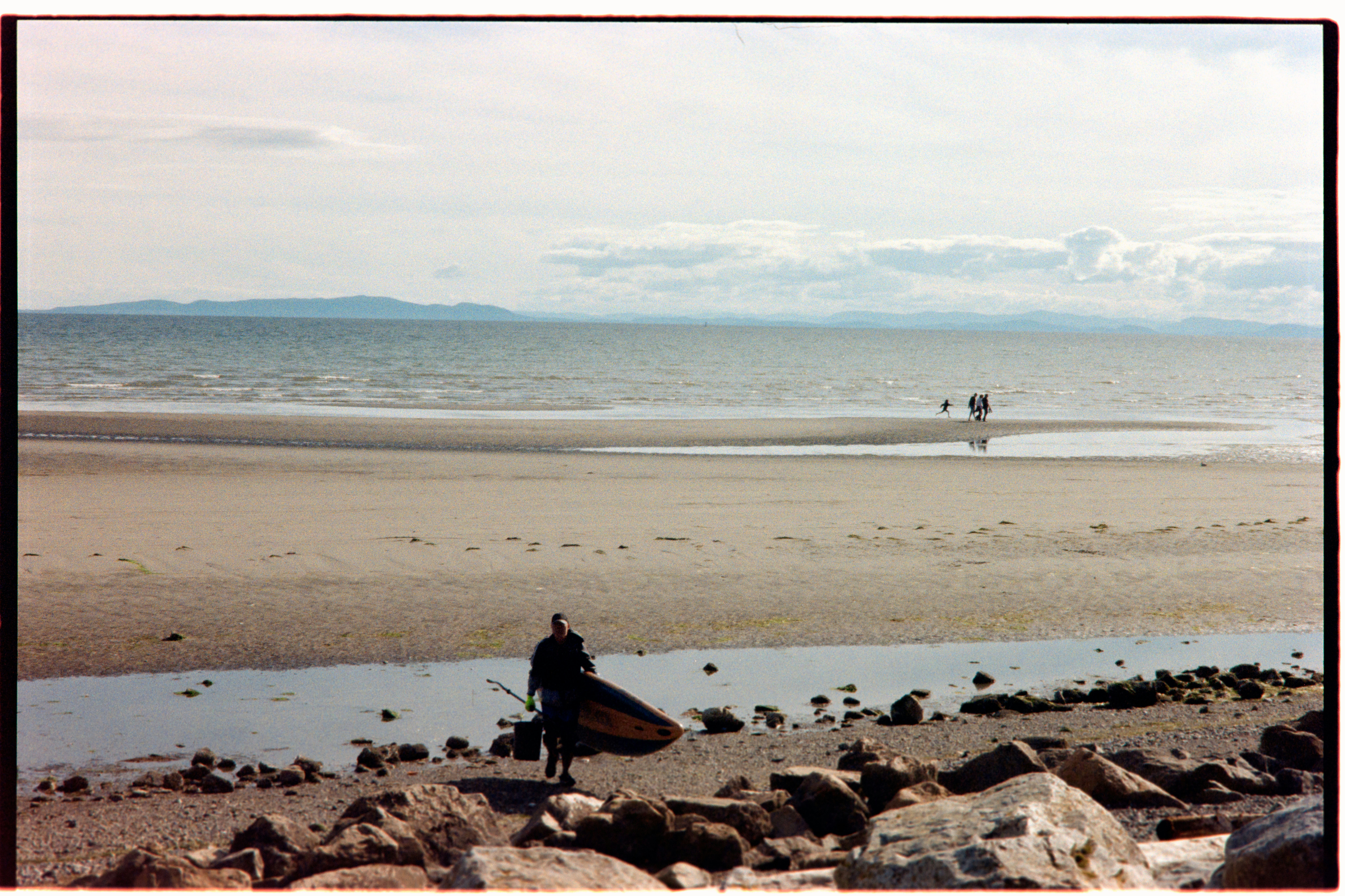Low Tide, Lone Surfer: A Quiet Seaside Moment