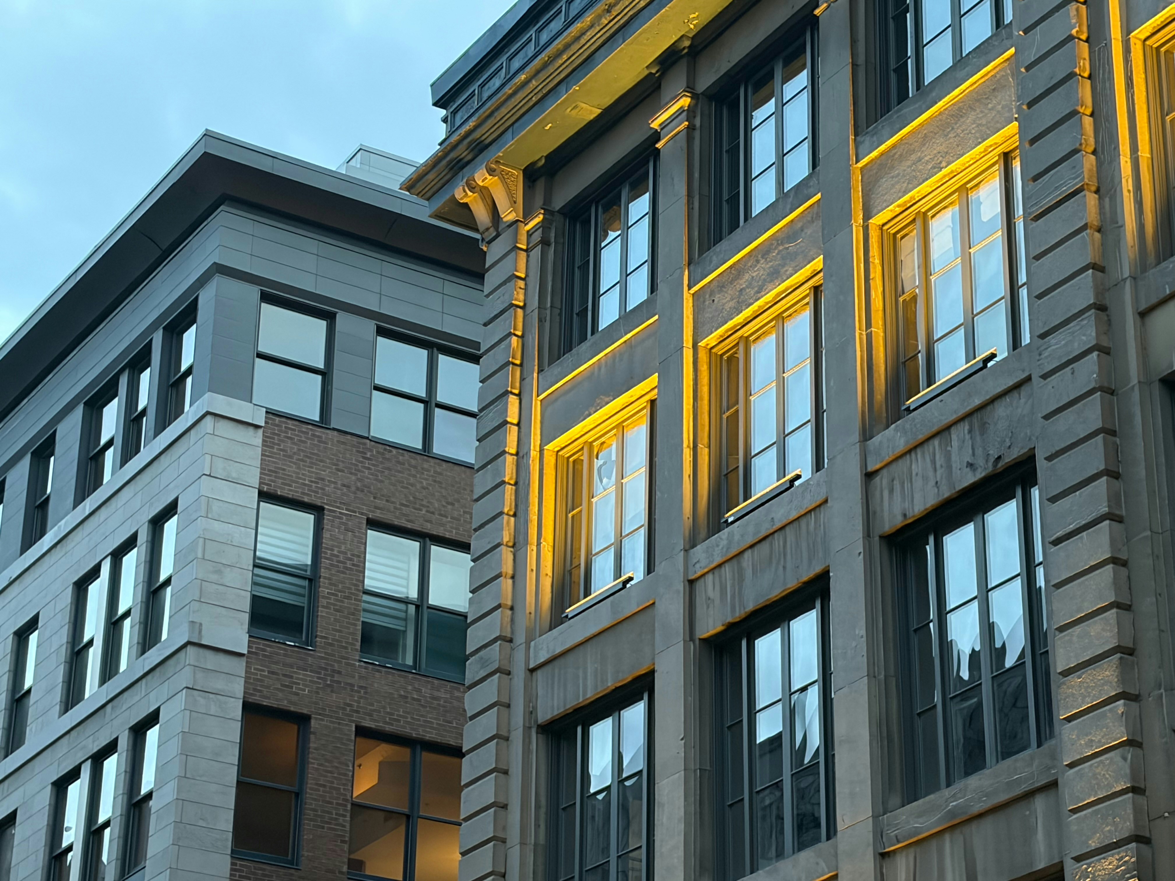 Golden Facade Echo: Sunlit Brick Meets Modern Glass