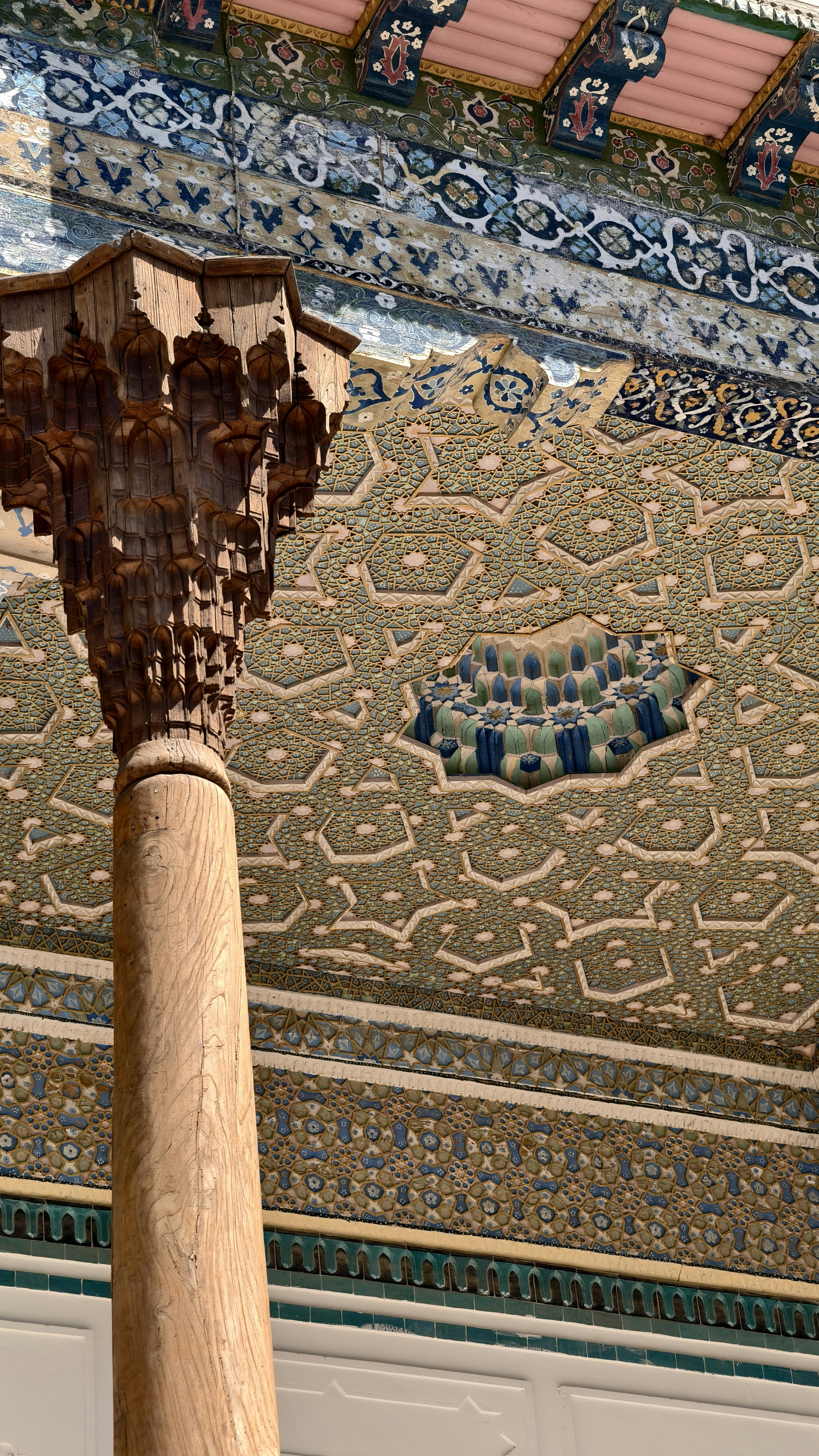 Carved Column Reaches Toward an Ornate Ceiling