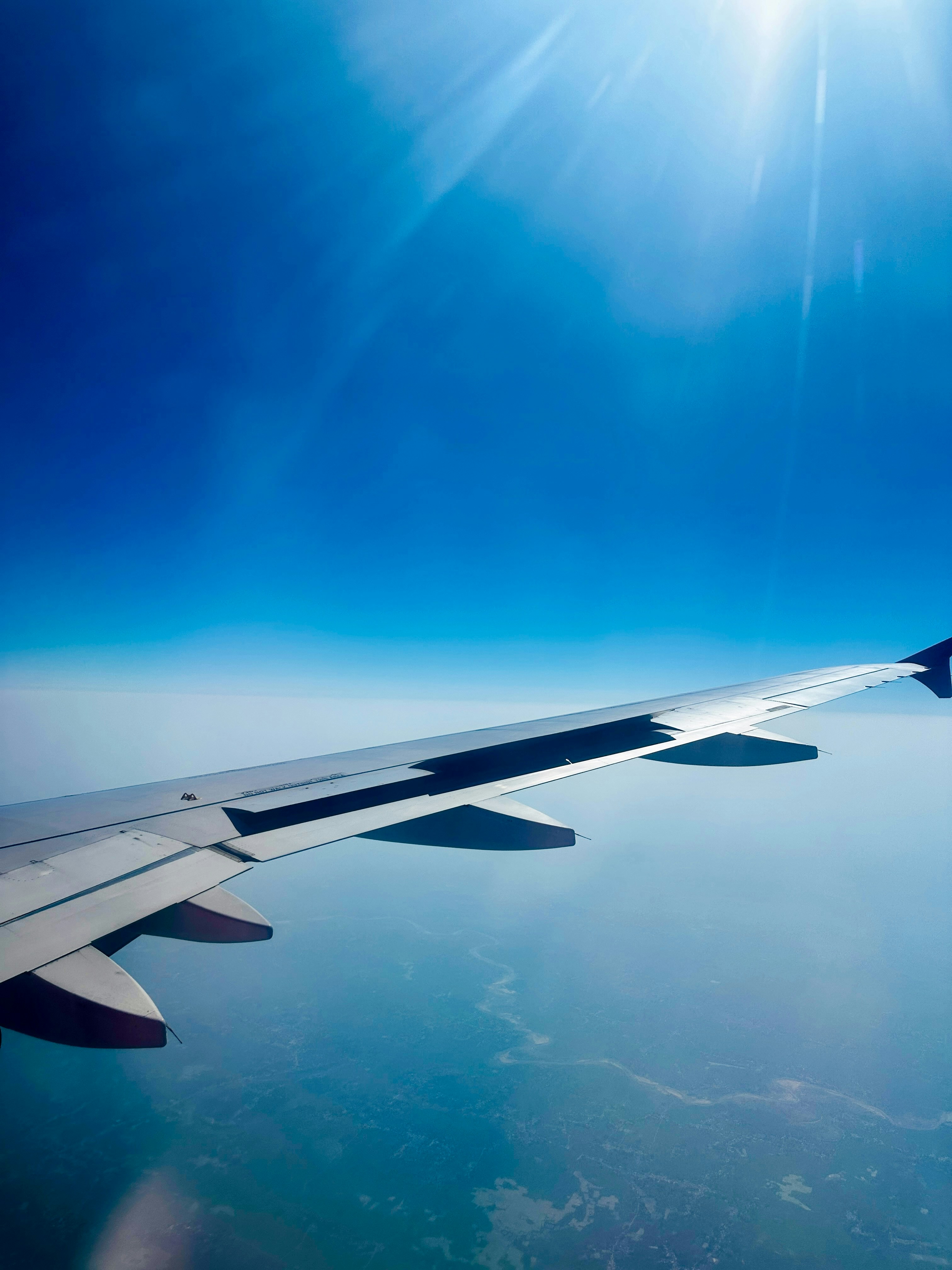 Skybound Flight: Wing, Sun, and Open Expanse
