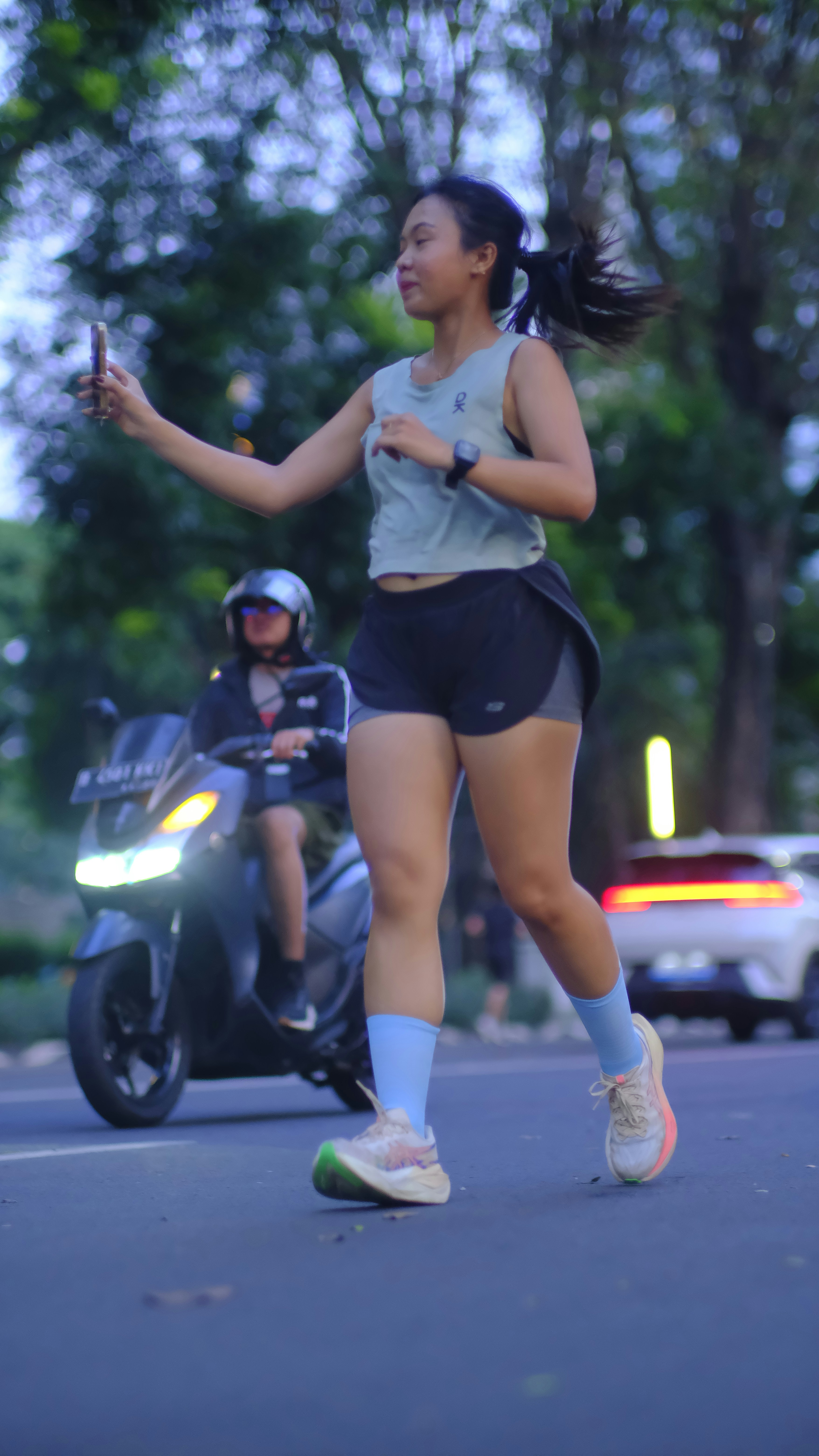 Runner in Motion: Selfie Moment Between Street Lights